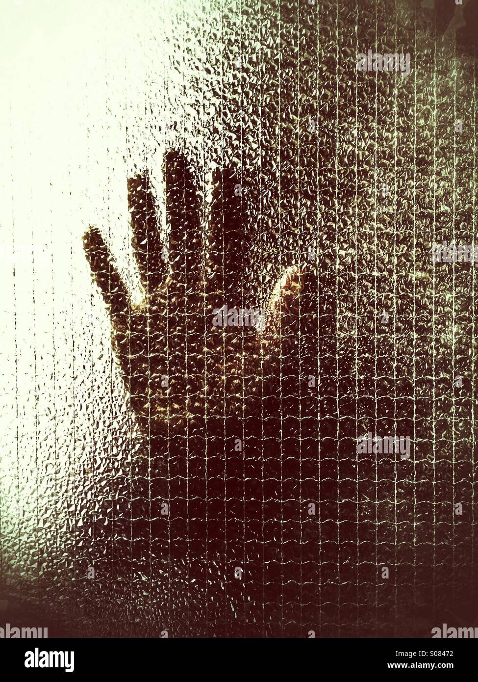 Man's hand behind glass Stock Photo - Alamy