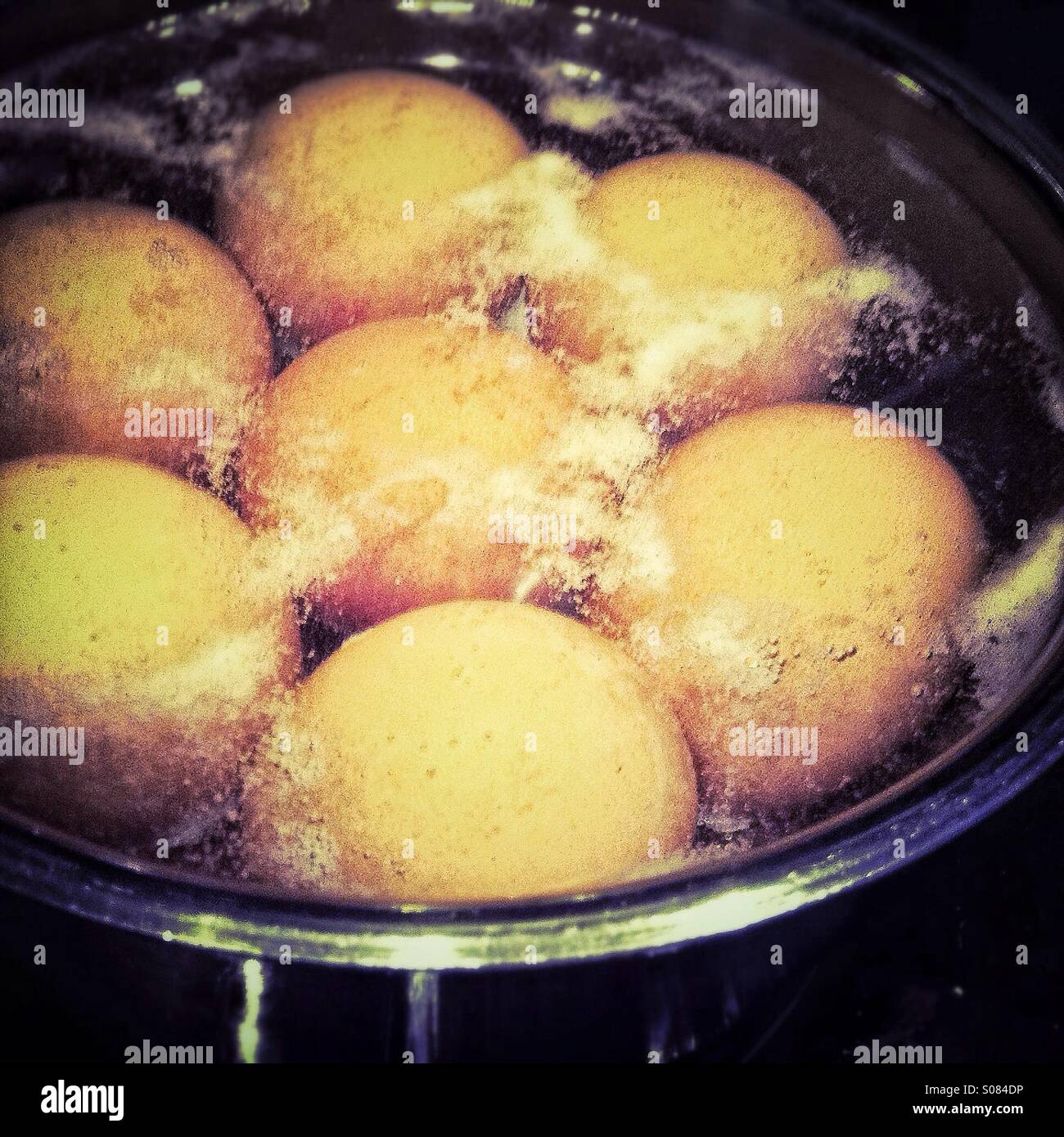 Eggs boiling in water Stock Photo - Alamy