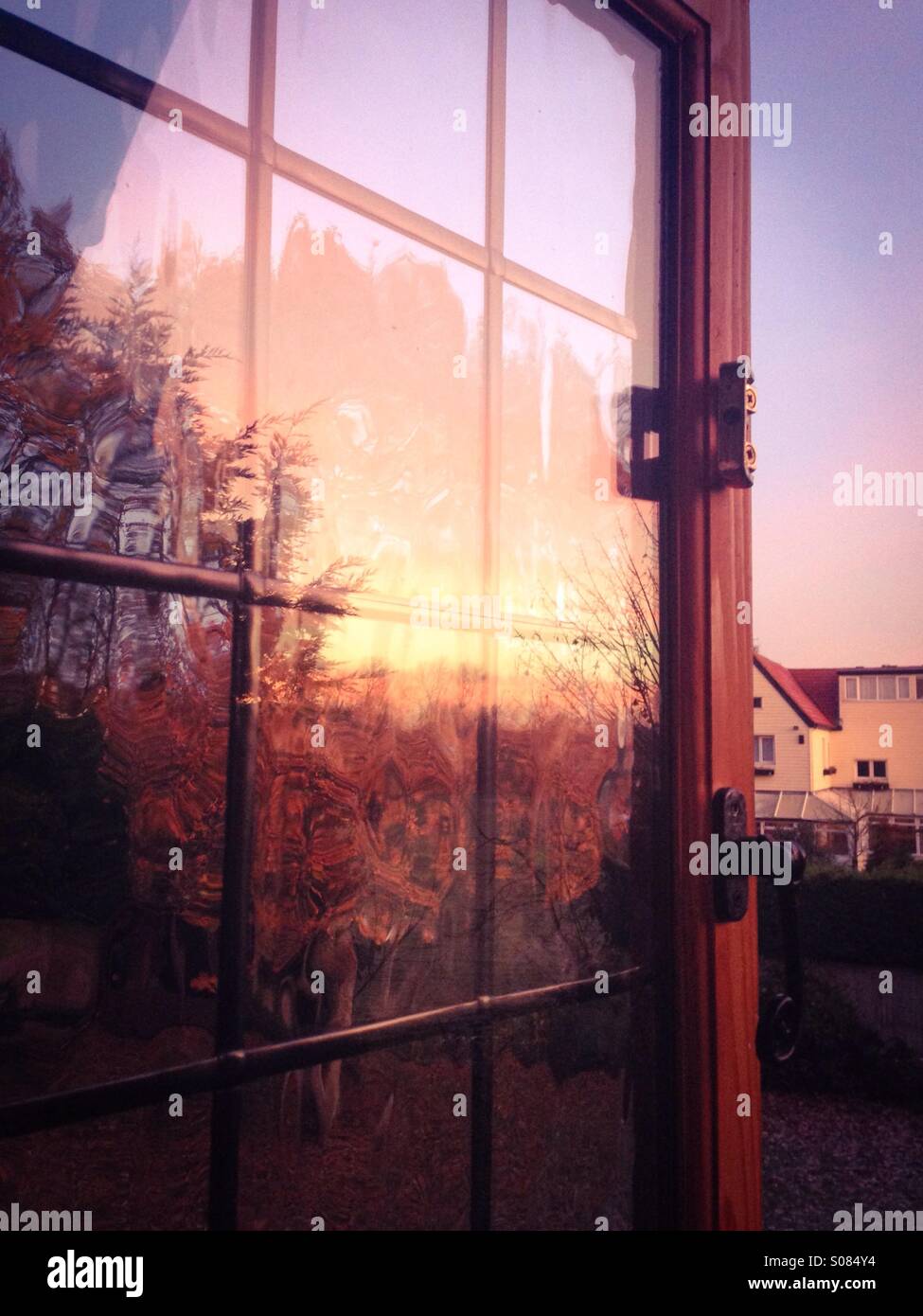 Sunrise reflecting in an open window Stock Photo - Alamy