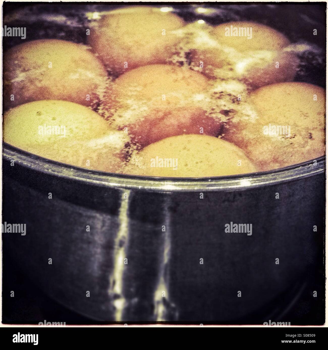 Eggs boiling in water Stock Photo - Alamy