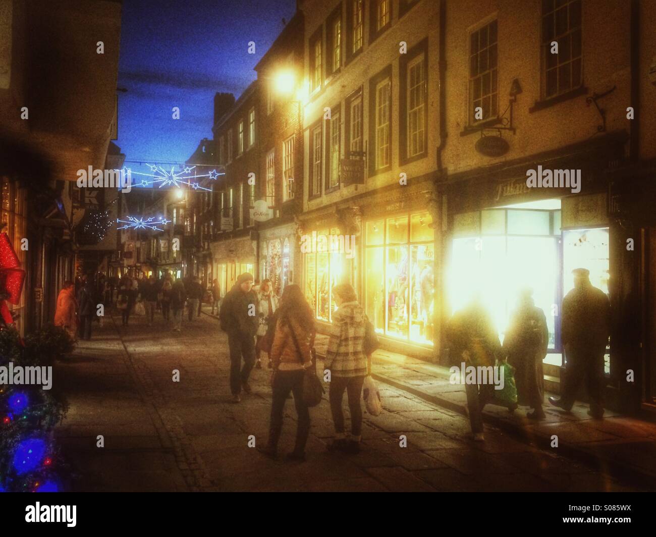 Brightly lit shops at night York North Yorkshire England UK Stock Photo ...