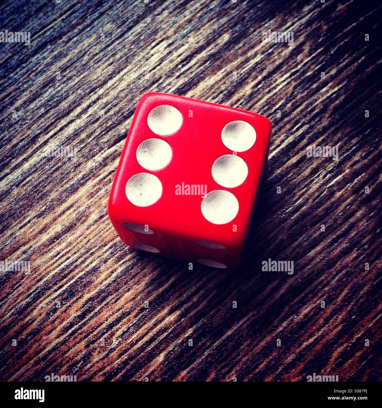 Red dice showing number 6 Stock Photo - Alamy