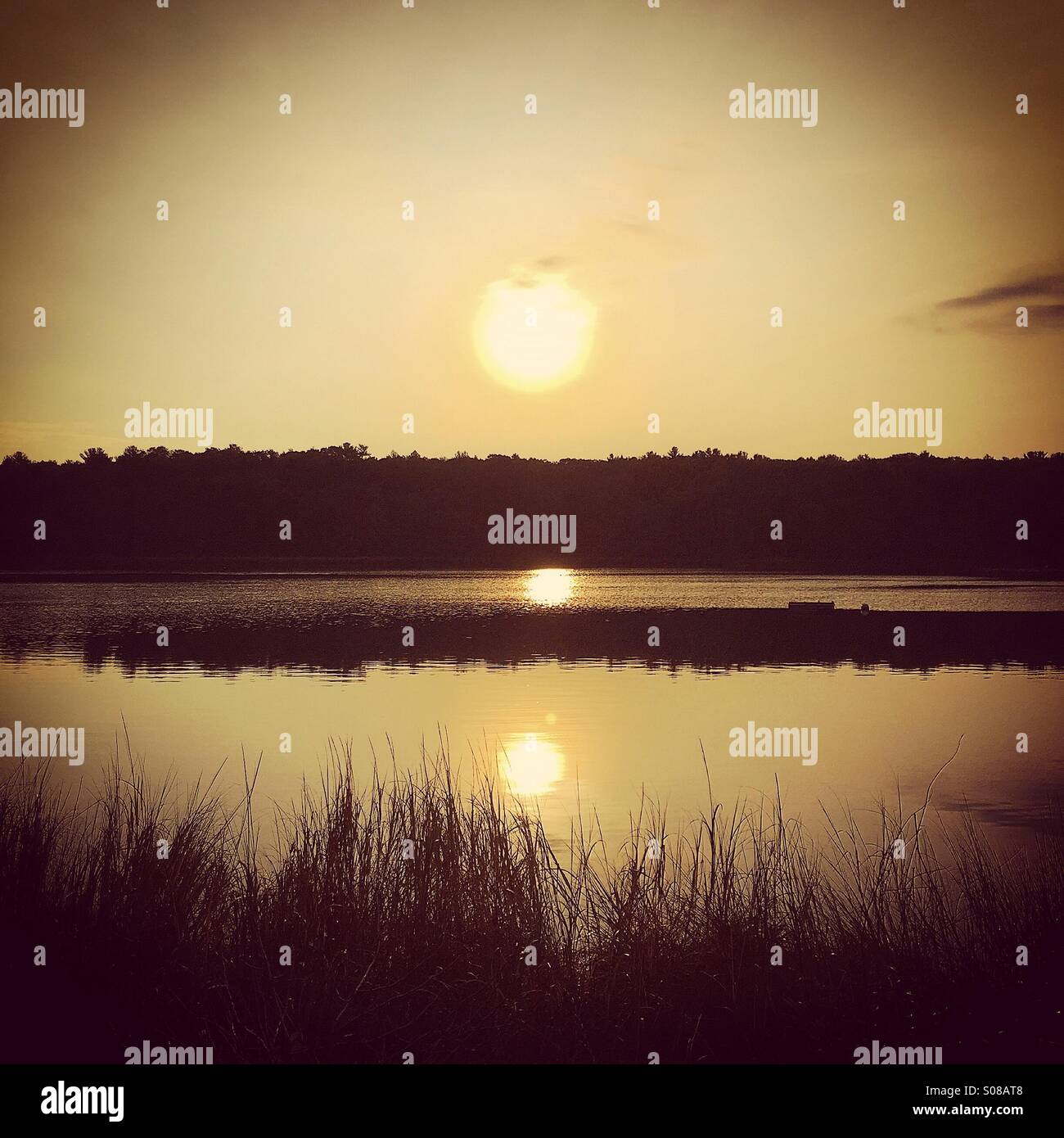 Sunrise over waterfront Stock Photo - Alamy