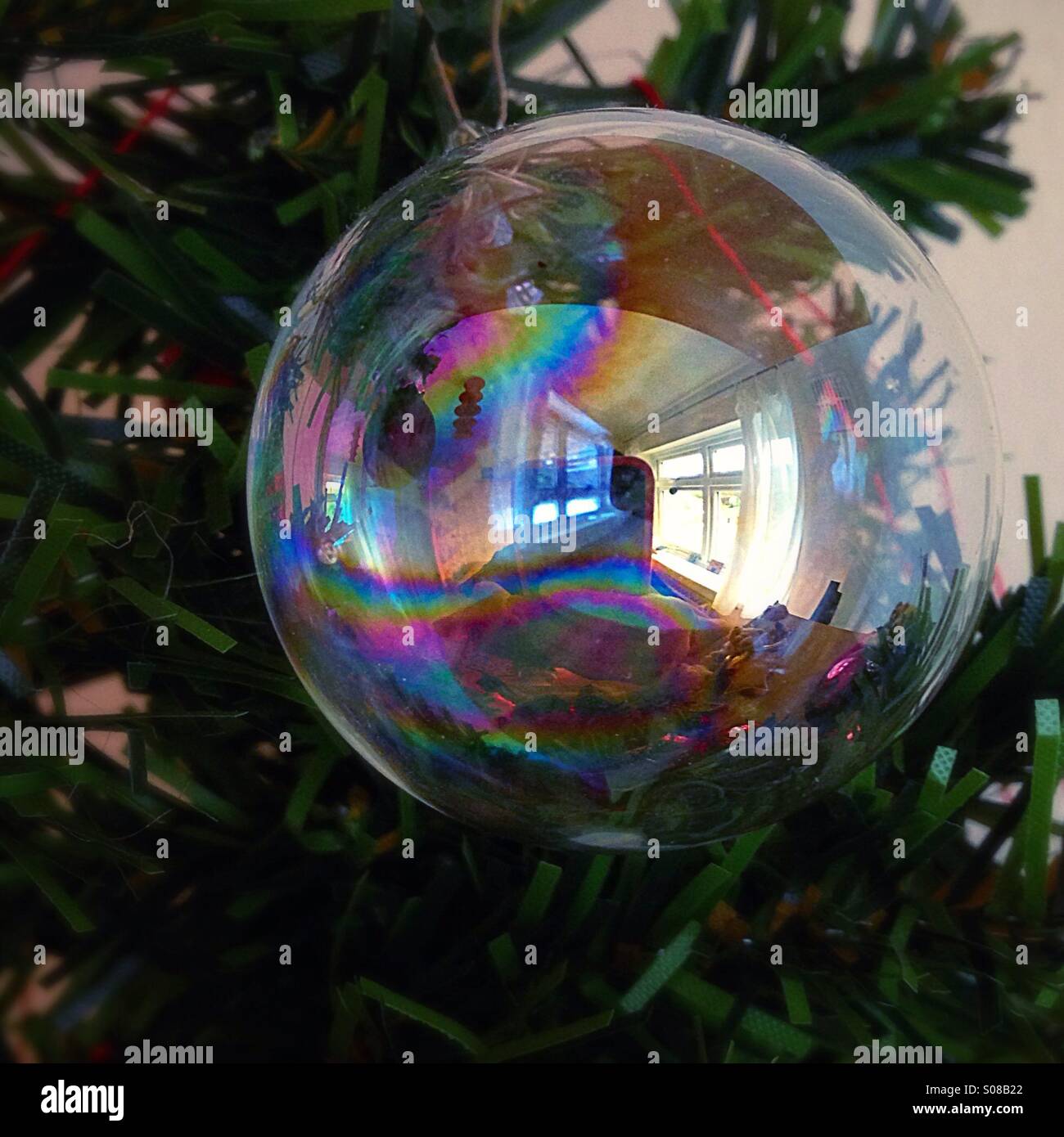 Reflection of a window in a crystal ball hanging from a Christmas tree ...