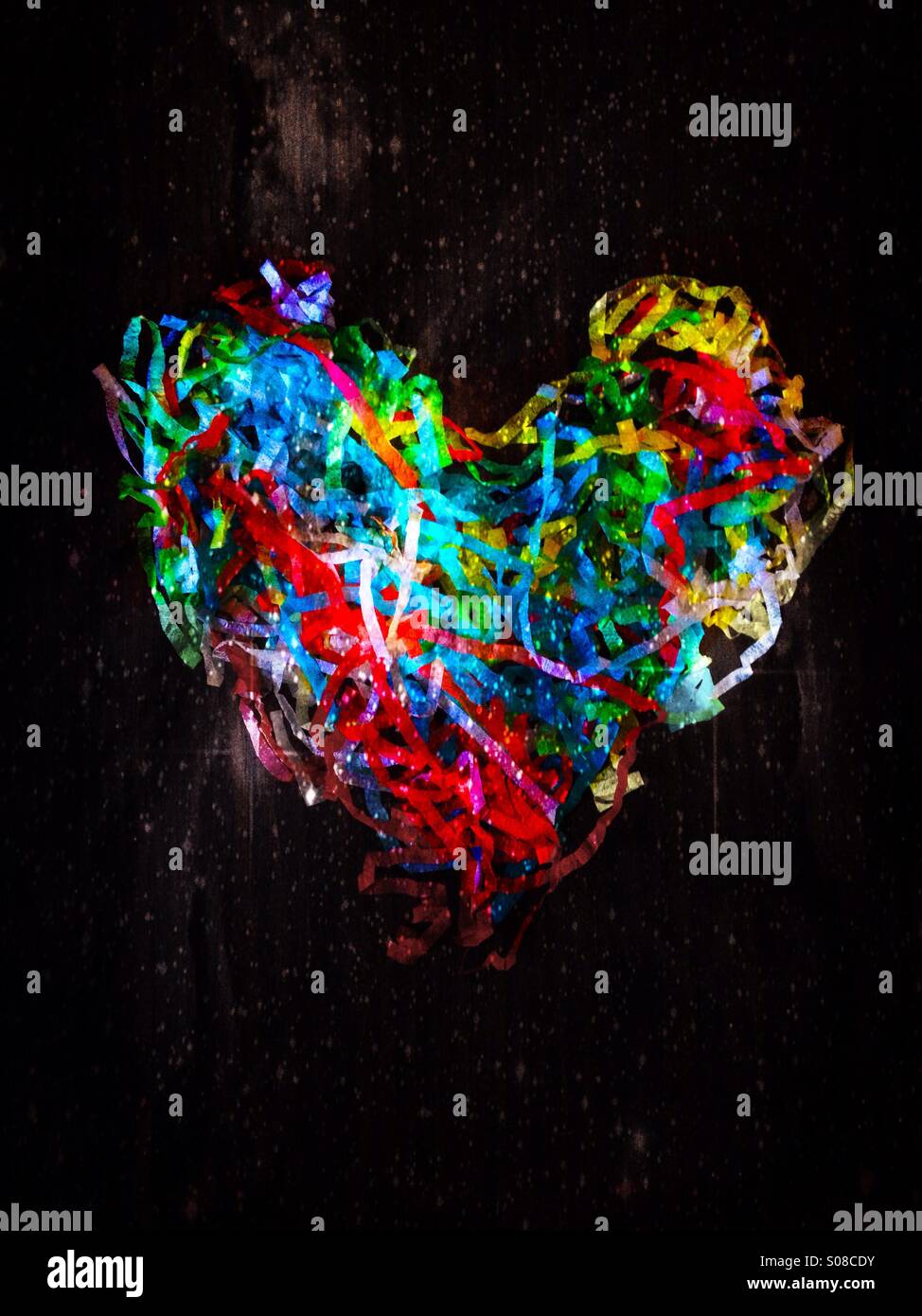 Colourful party streamers in the shape of a love heart Stock Photo - Alamy