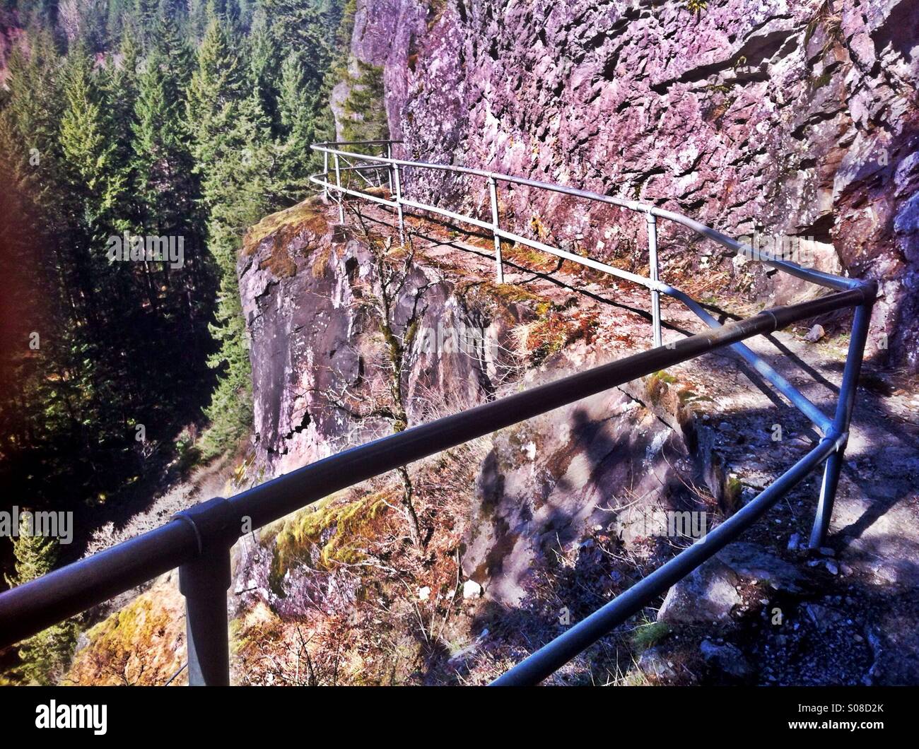 Hiking trail along cliff ledge Stock Photo - Alamy