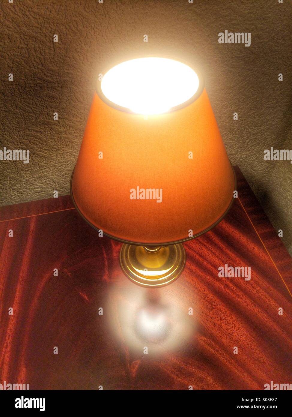Small table light switched on in a room Stock Photo - Alamy