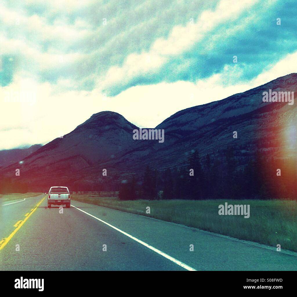 Truck driving down highway in Canada Stock Photo - Alamy