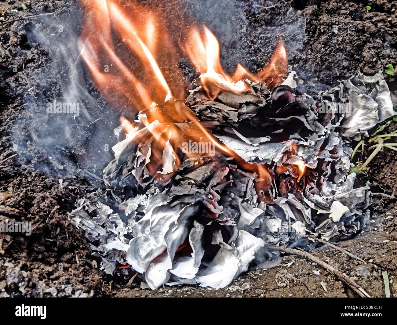 Rubbish on fire Stock Photo - Alamy