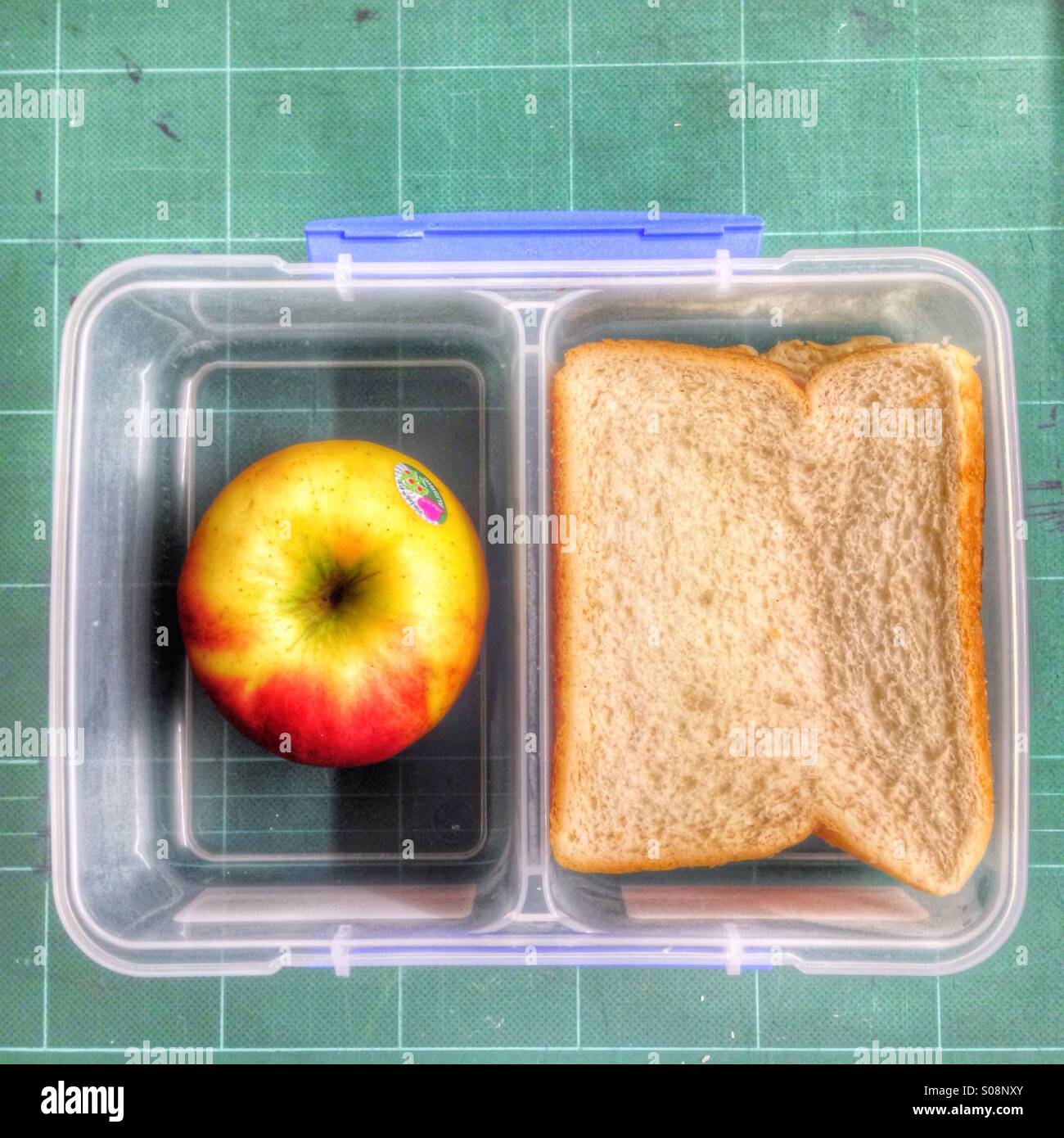 Lunch box with an apple and a sandwich Stock Photo - Alamy