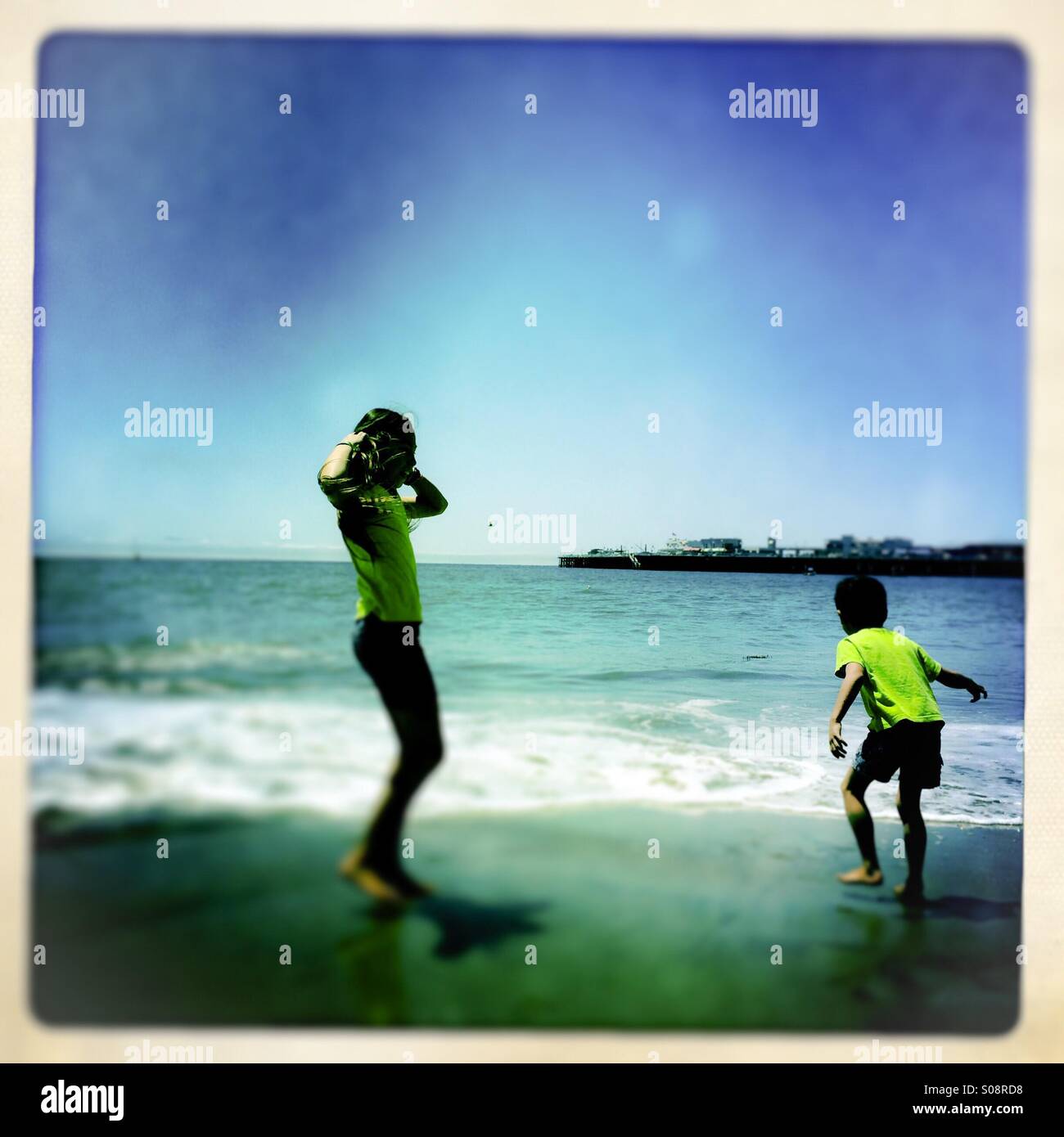 Kids running from waves hi-res stock photography and images - Alamy