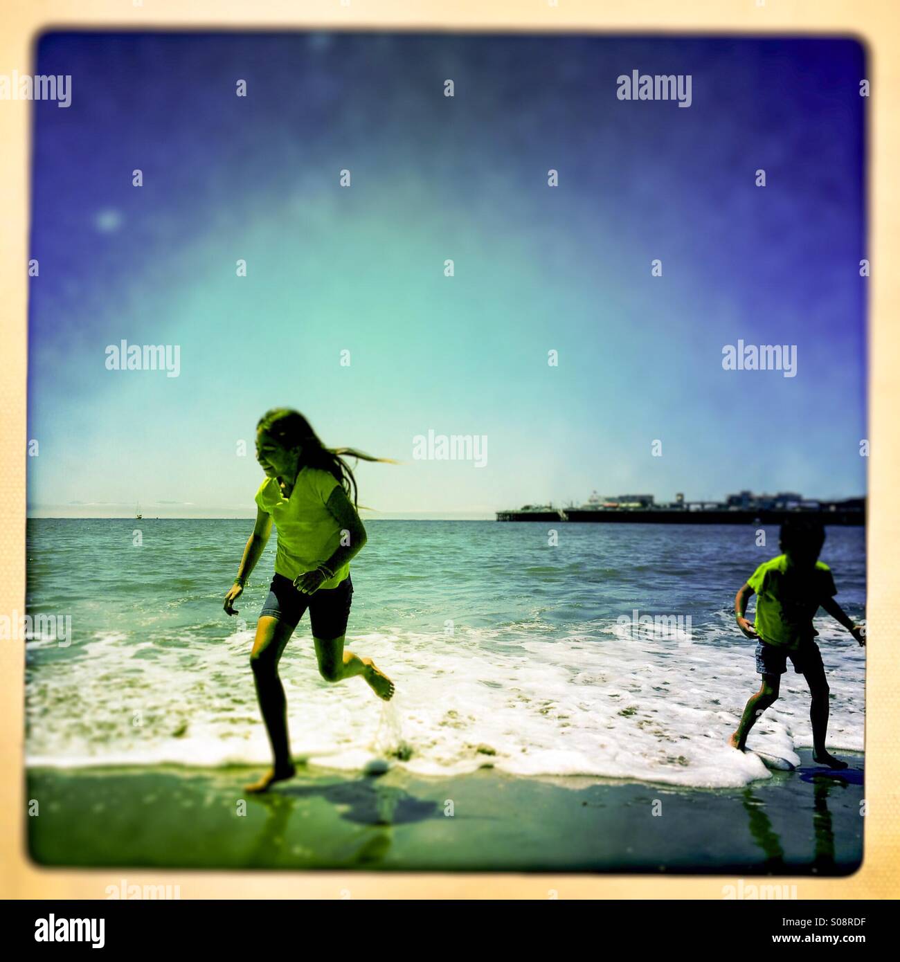 Kids running from waves hi-res stock photography and images - Alamy