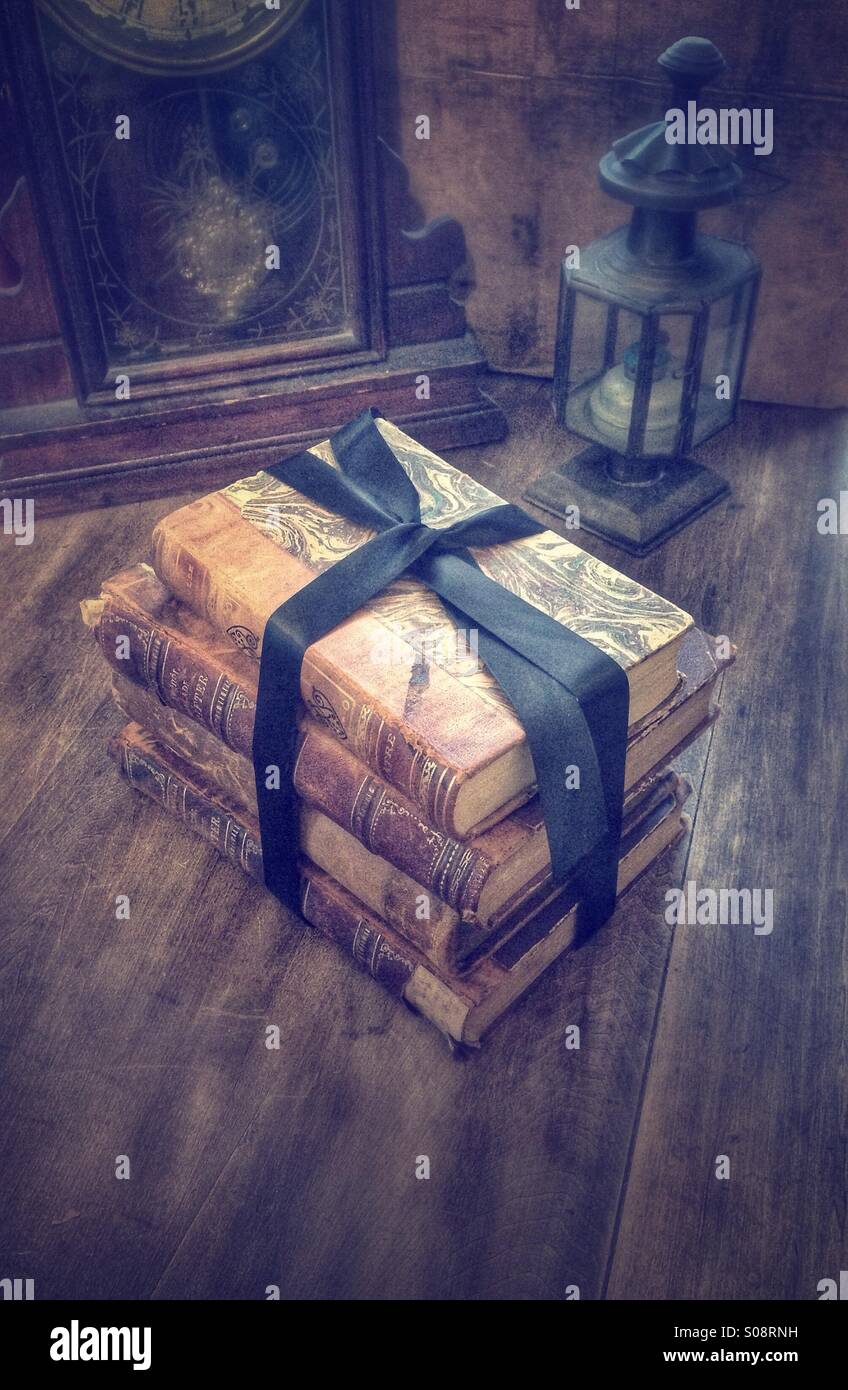 Antique books tied with ribbon Stock Photo - Alamy