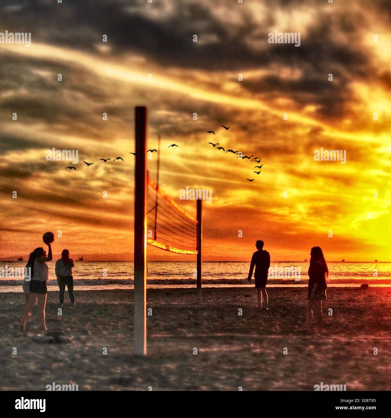 A Game Of Beach Volleyball End Of Day At Sunset Stock Photo - Alamy