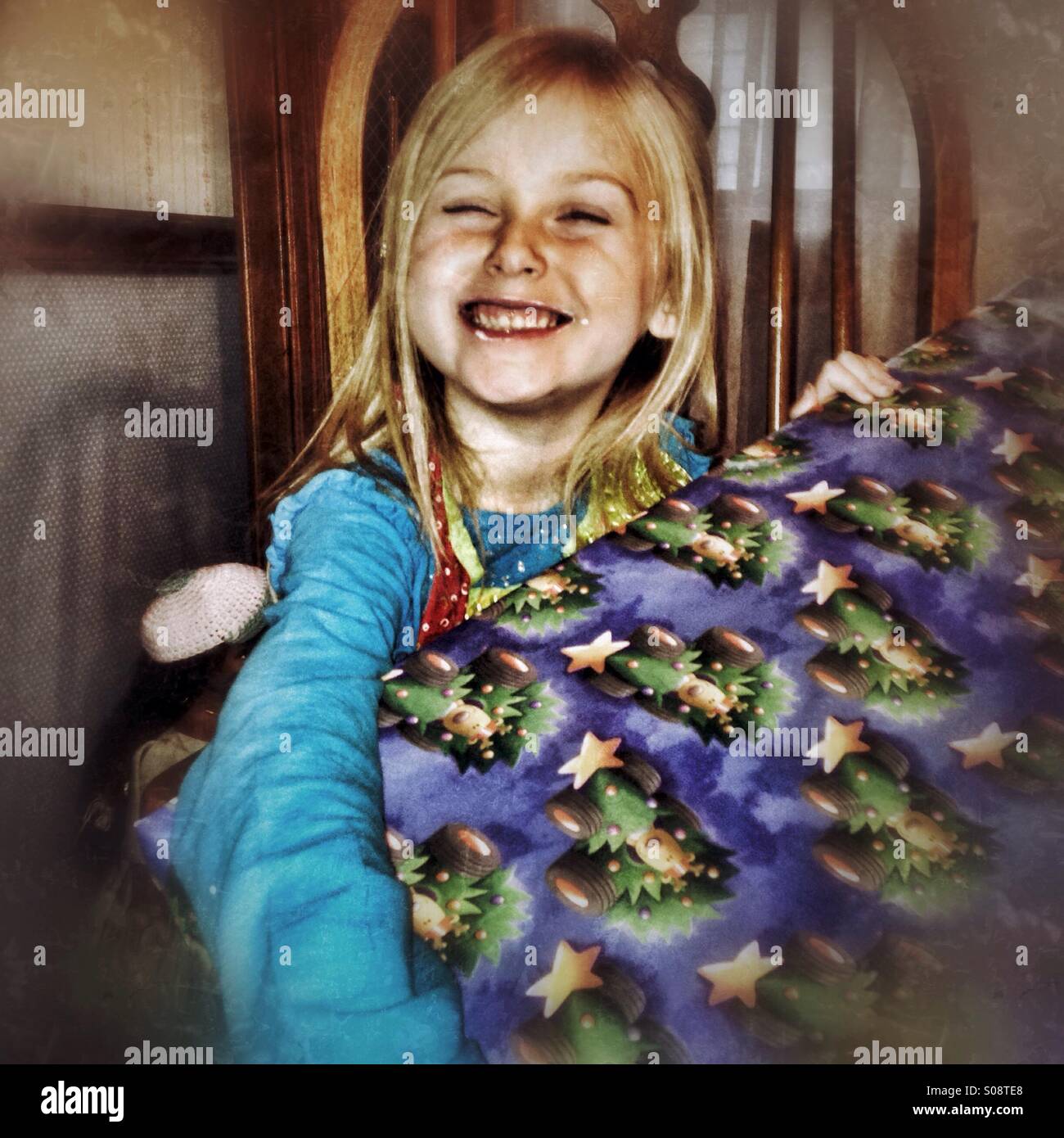 A girl with a Christmas gift smiling with frosting covered lips Stock ...