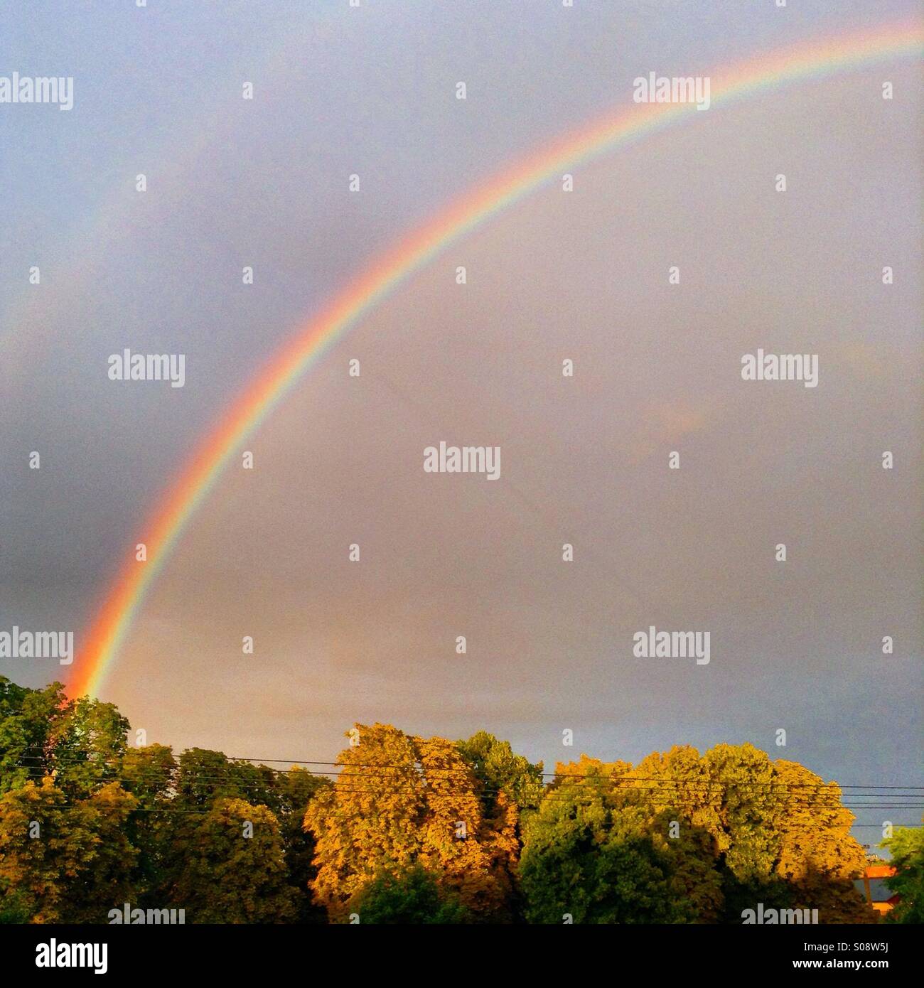 Rainbow over autumn foliage Stock Photo - Alamy