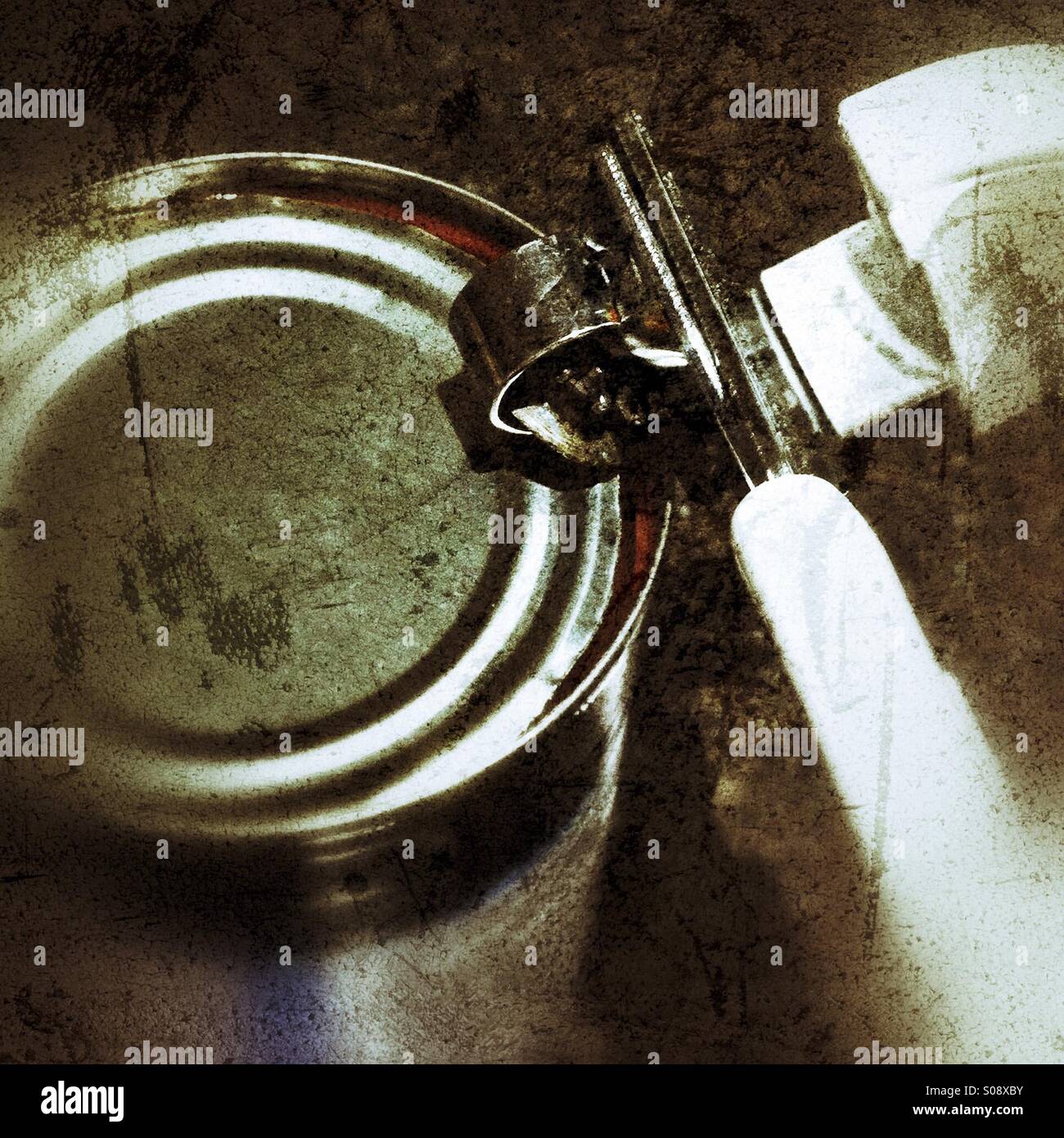 Tin opener and tin Stock Photo - Alamy