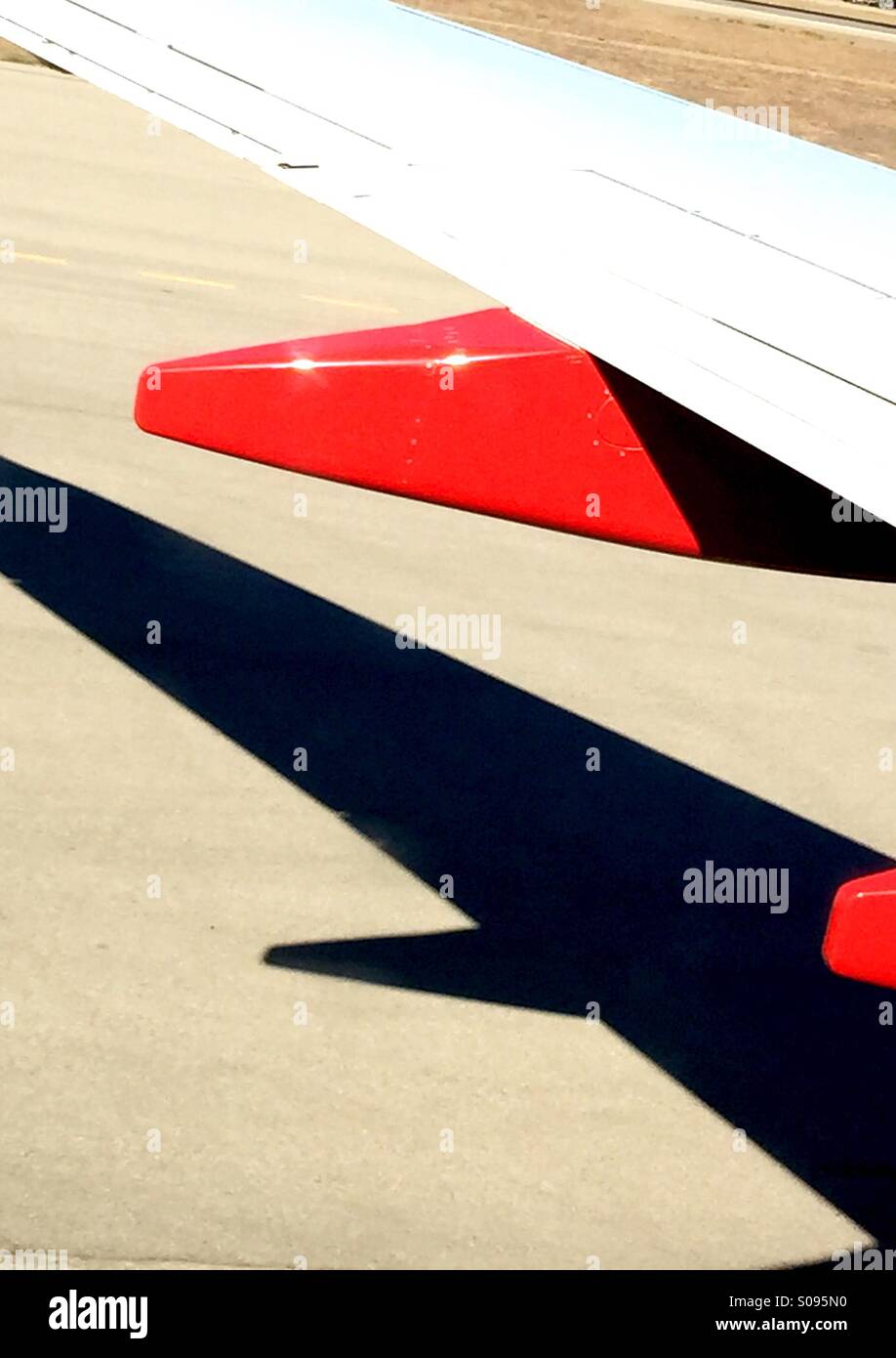 Airplane wing and shadow Stock Photo - Alamy