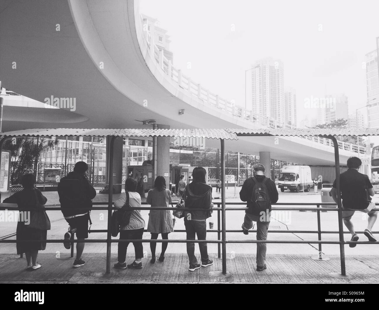 Commuters waiting at bus stop hi-res stock photography and images - Alamy