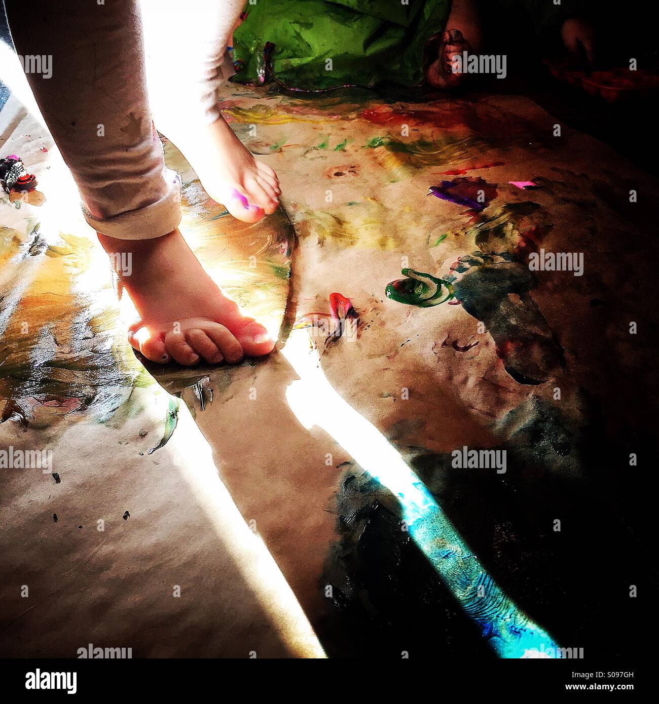 Creating art with toes in paint Stock Photo - Alamy