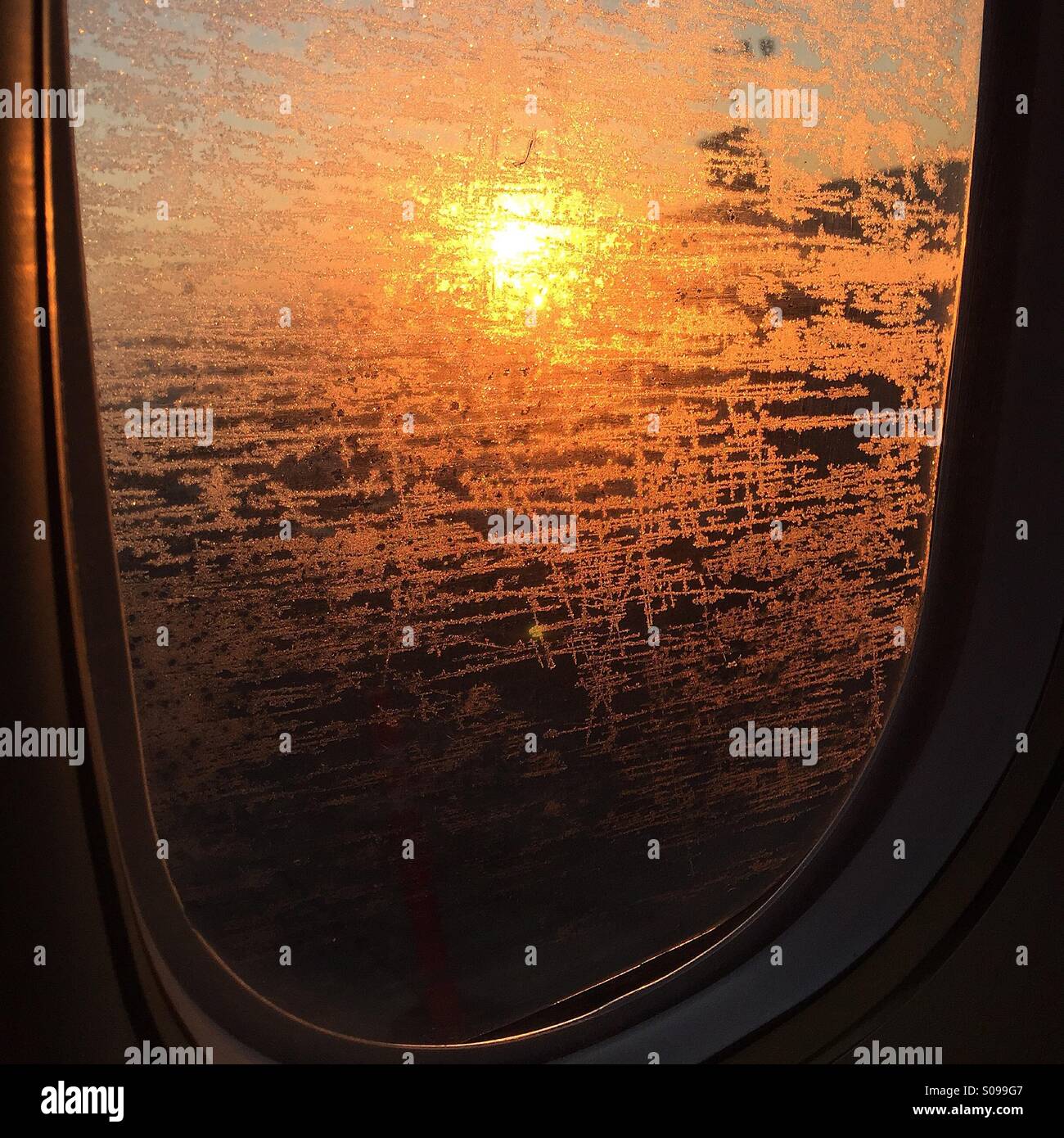 Sunrise through a clouded airplane window Stock Photo - Alamy