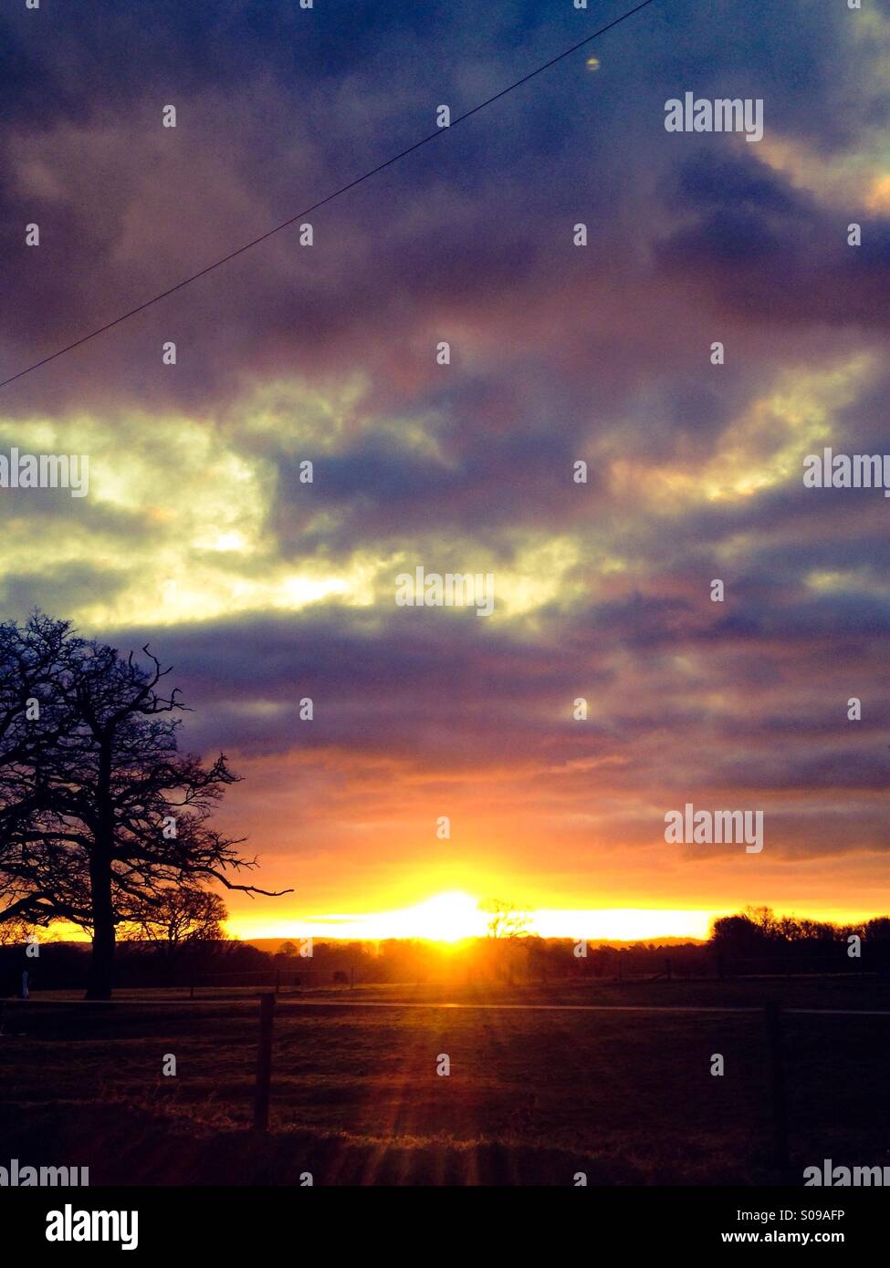 Sunrise over field Stock Photo - Alamy
