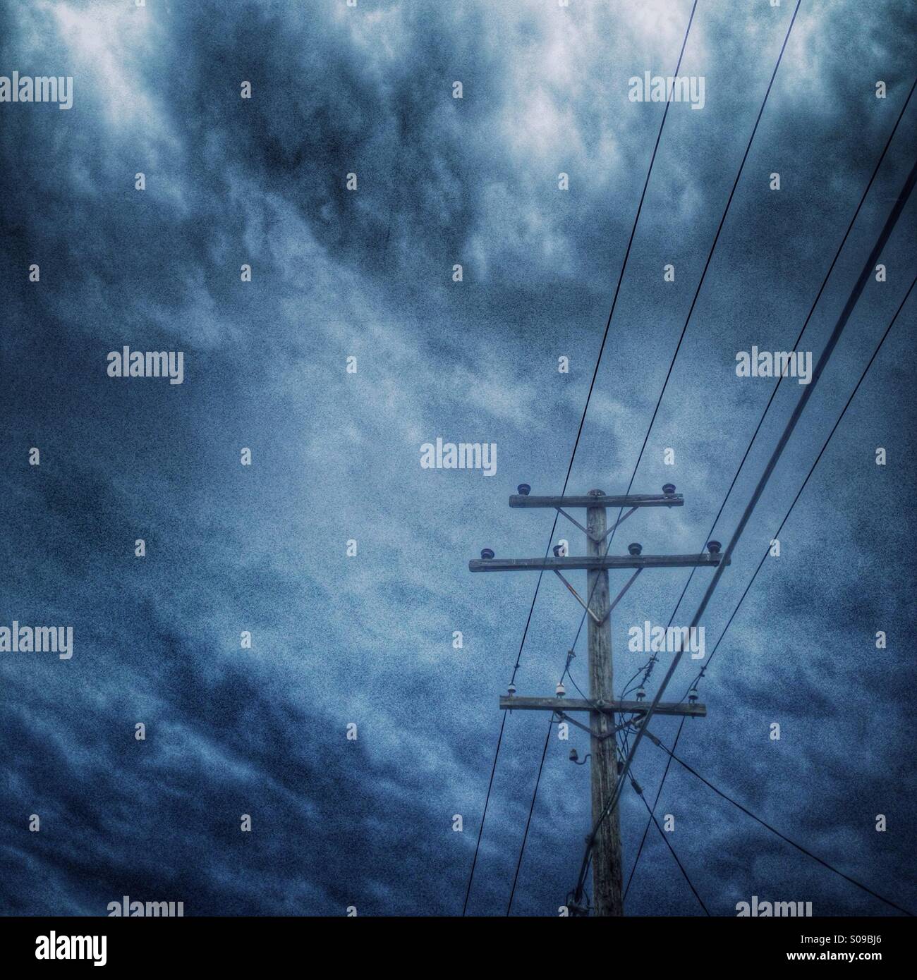 Power lines against a stormy sky Stock Photo - Alamy