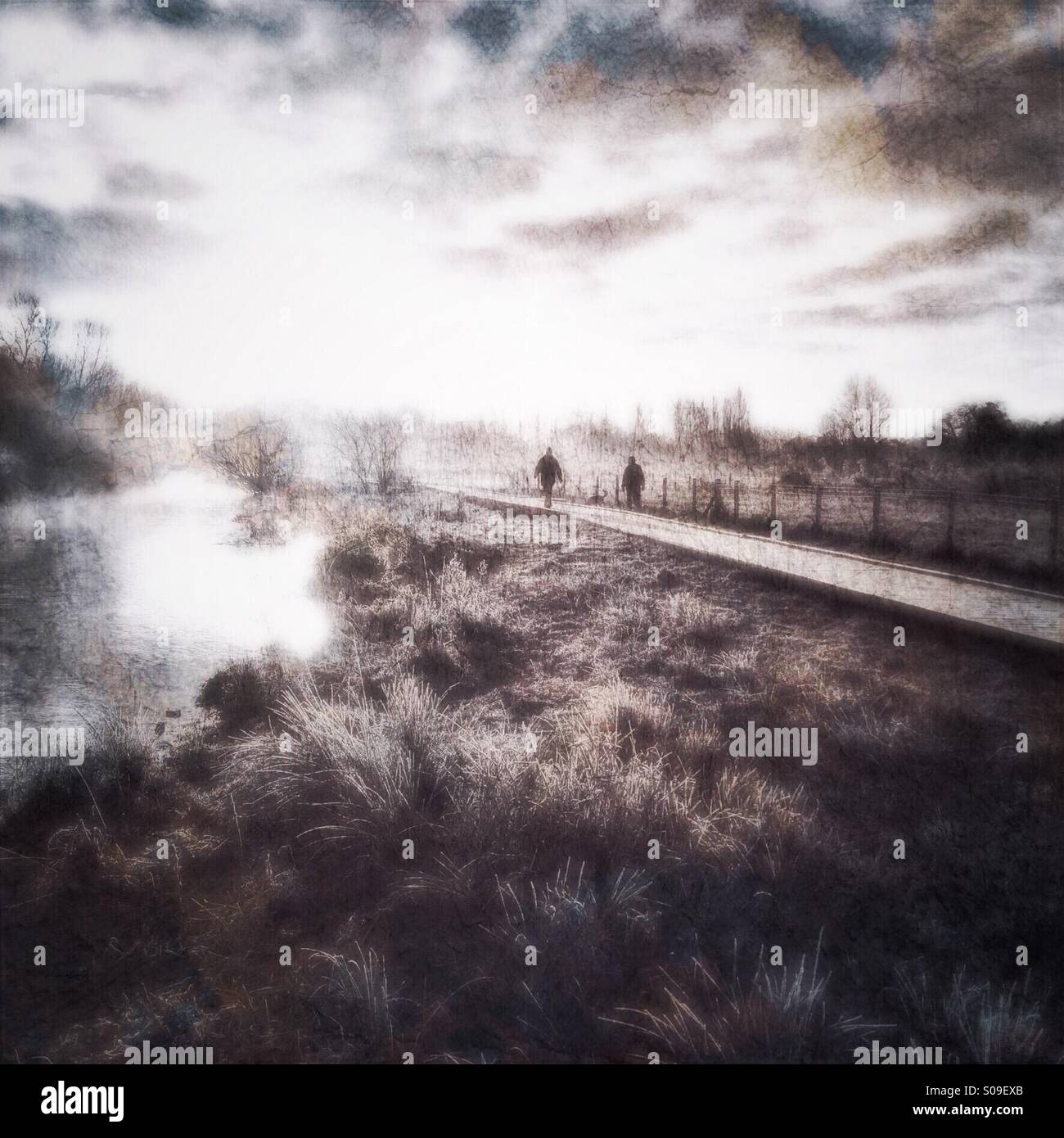 People walking next to river Stock Photo - Alamy