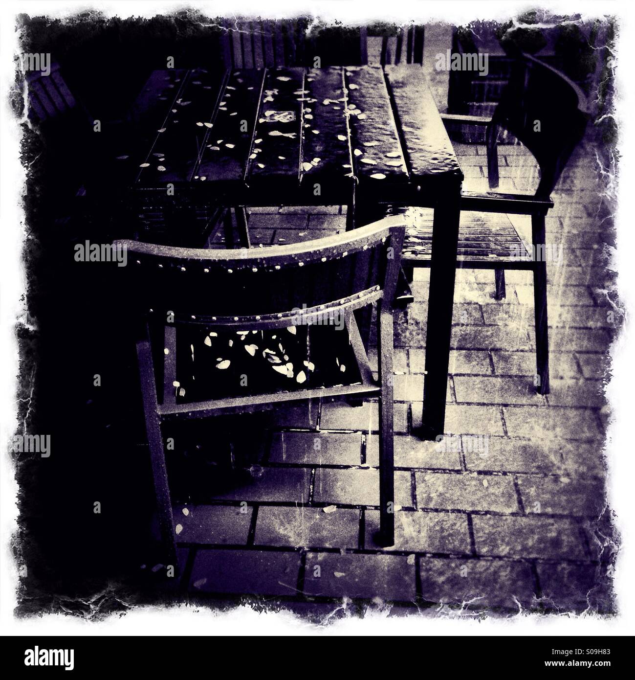 Coffee table and chairs under heavy rain Stock Photo - Alamy