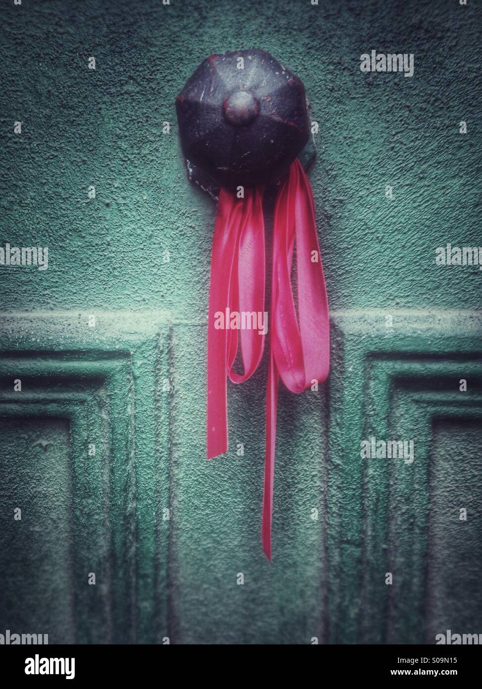 Red ribbon attached to a door handle Stock Photo - Alamy