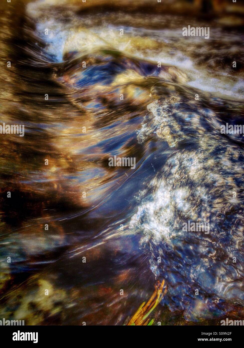 Fast flowing stream over weir Stock Photo - Alamy