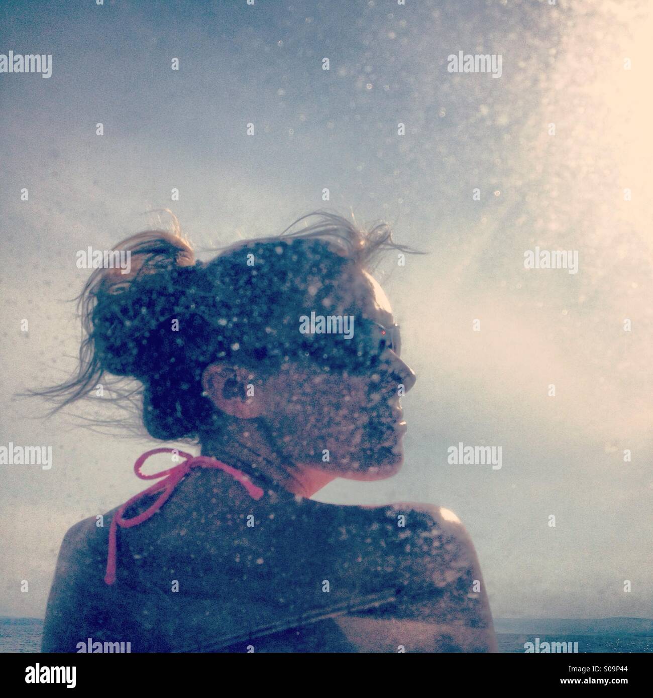 A young woman shot through. Glass covered in dried salt water Stock ...