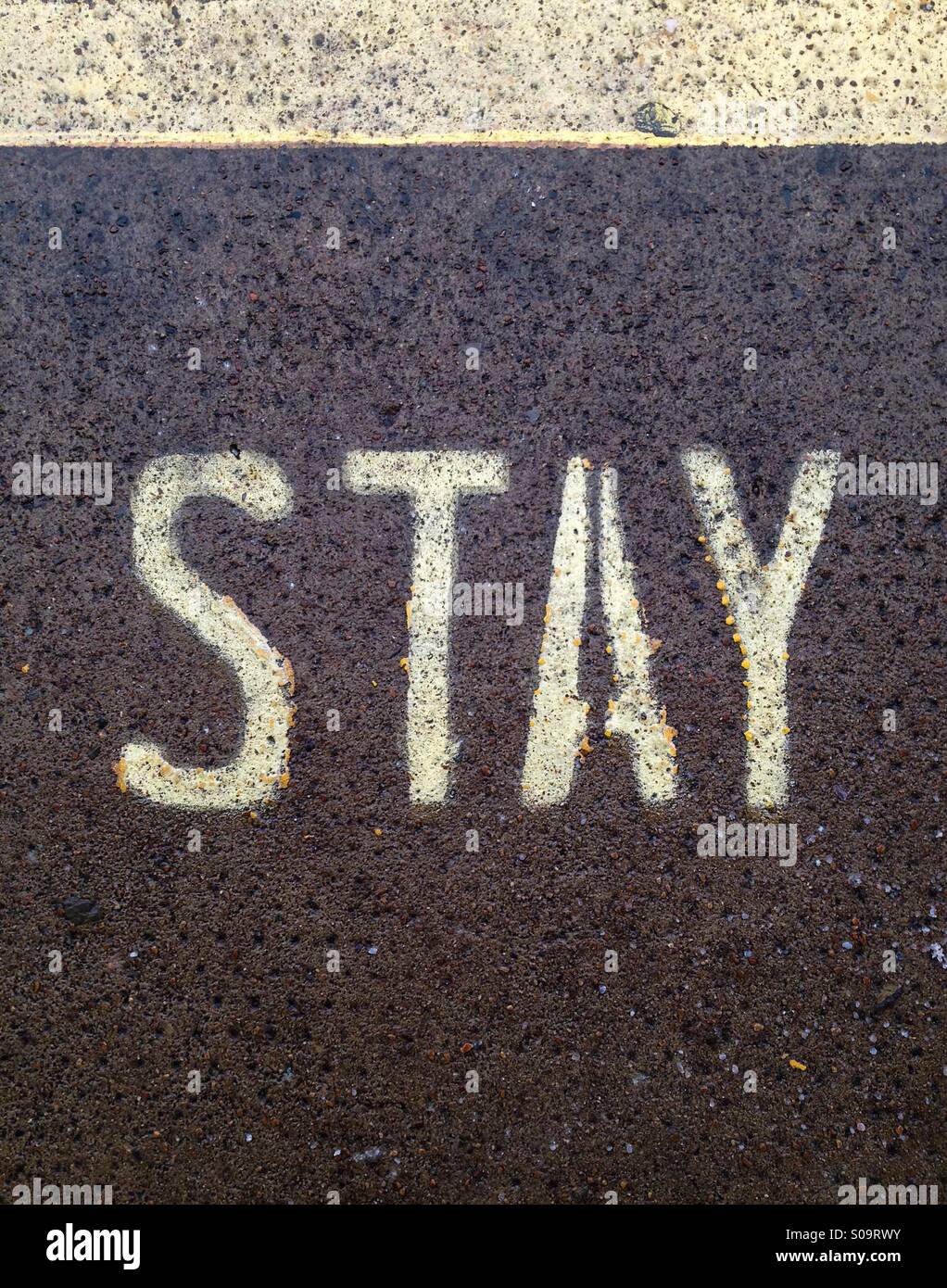 Stay sign on concrete Stock Photo - Alamy