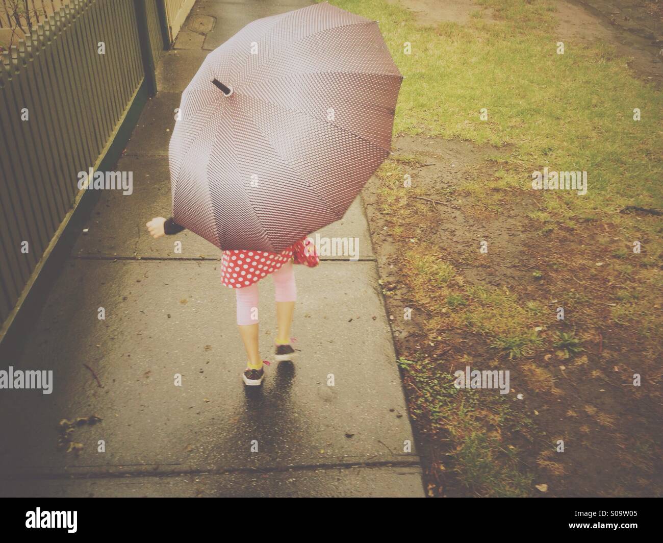 Girl walking under the rain hi-res stock photography and images - Alamy