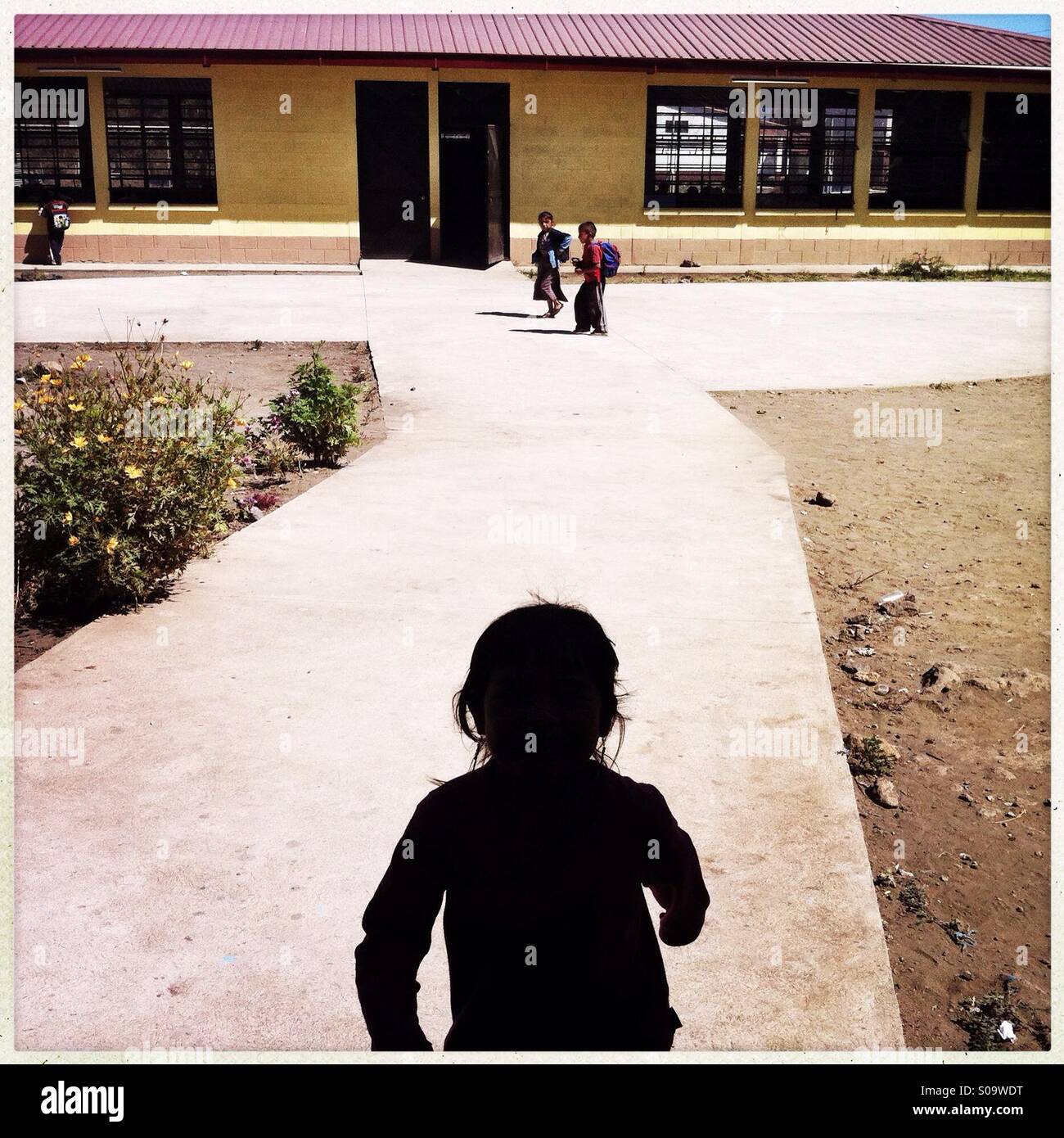 A silhouette of Mayan girl running at school in Chukmuk, Guatemala ...