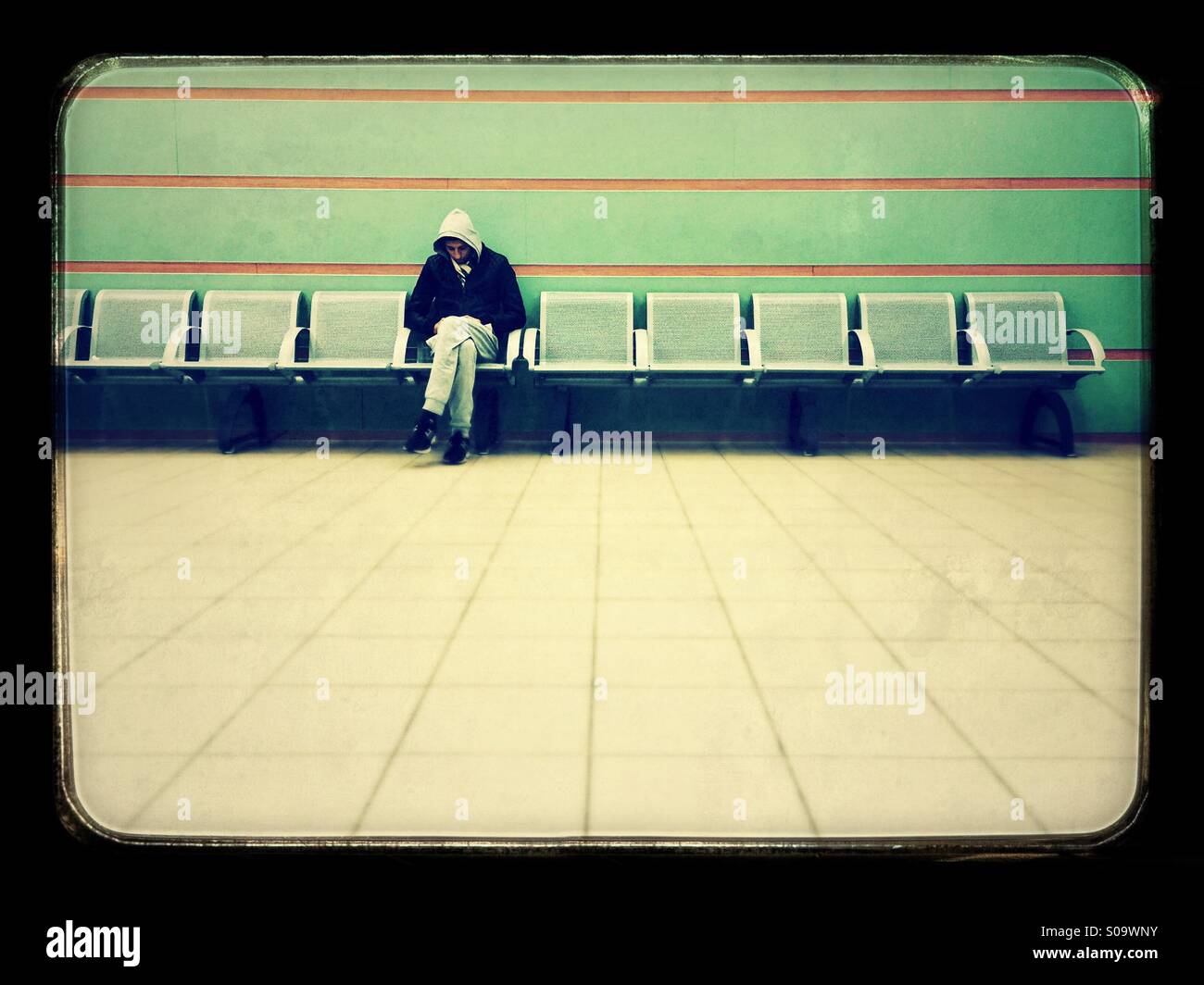 Young Man alone in a waiting room Stock Photo - Alamy