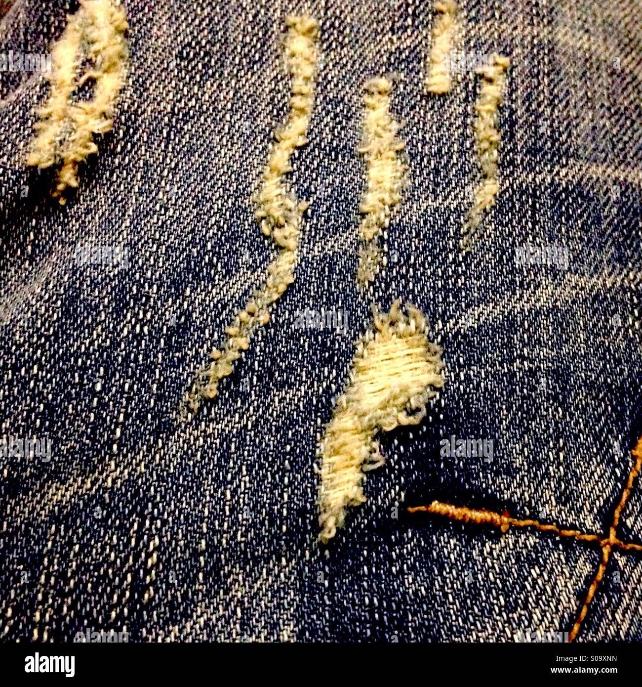 Ripped denim texture Stock Photo - Alamy