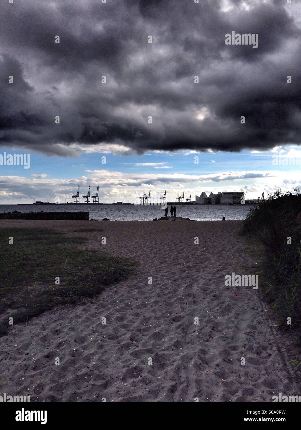Scandinavian landscape, storm in the beach, with huge and dark clouds ...