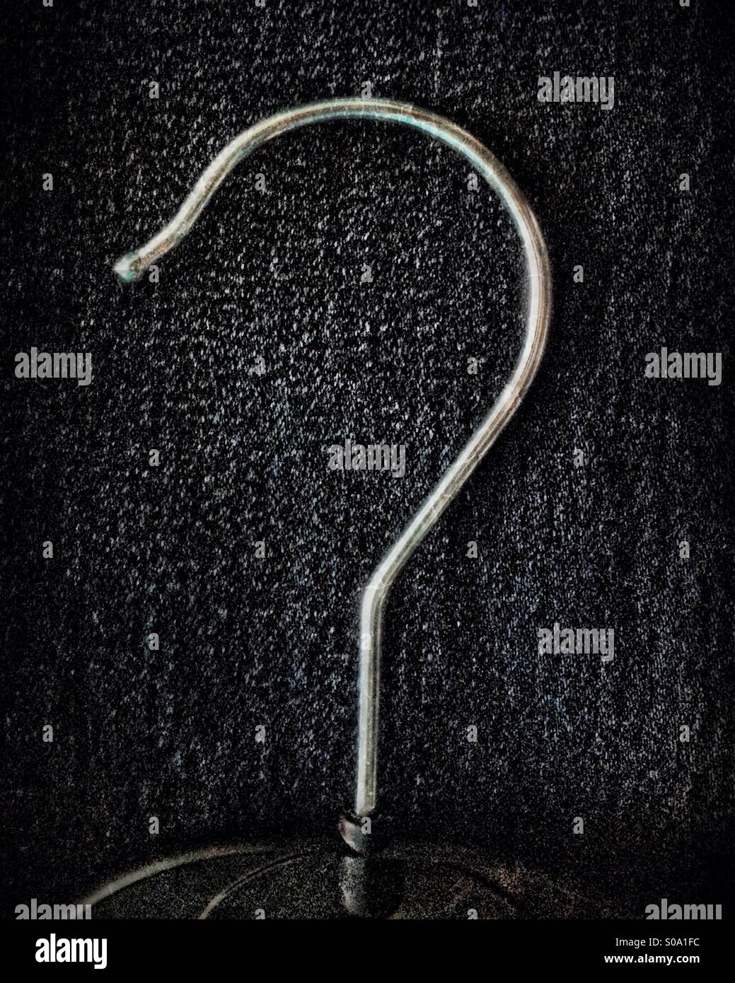 Coat hanger like a question mark Stock Photo - Alamy