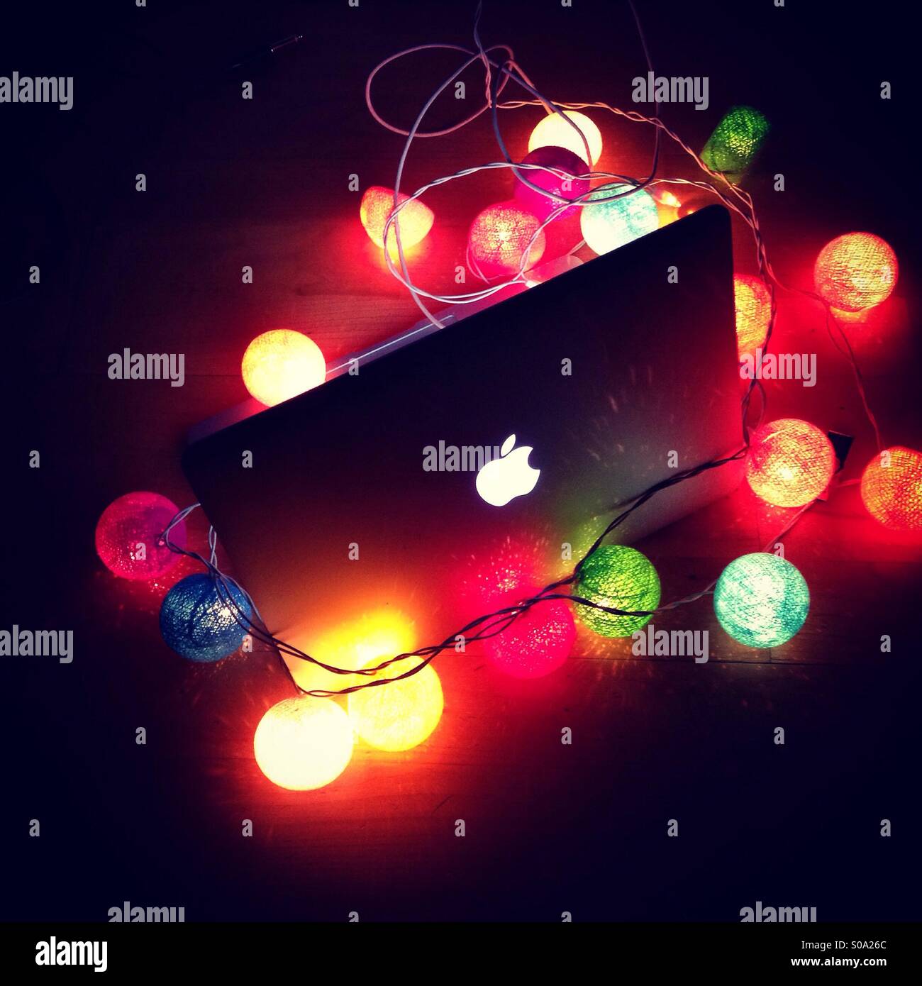 Computer Apple on the floor with colorful lights around Stock Photo - Alamy