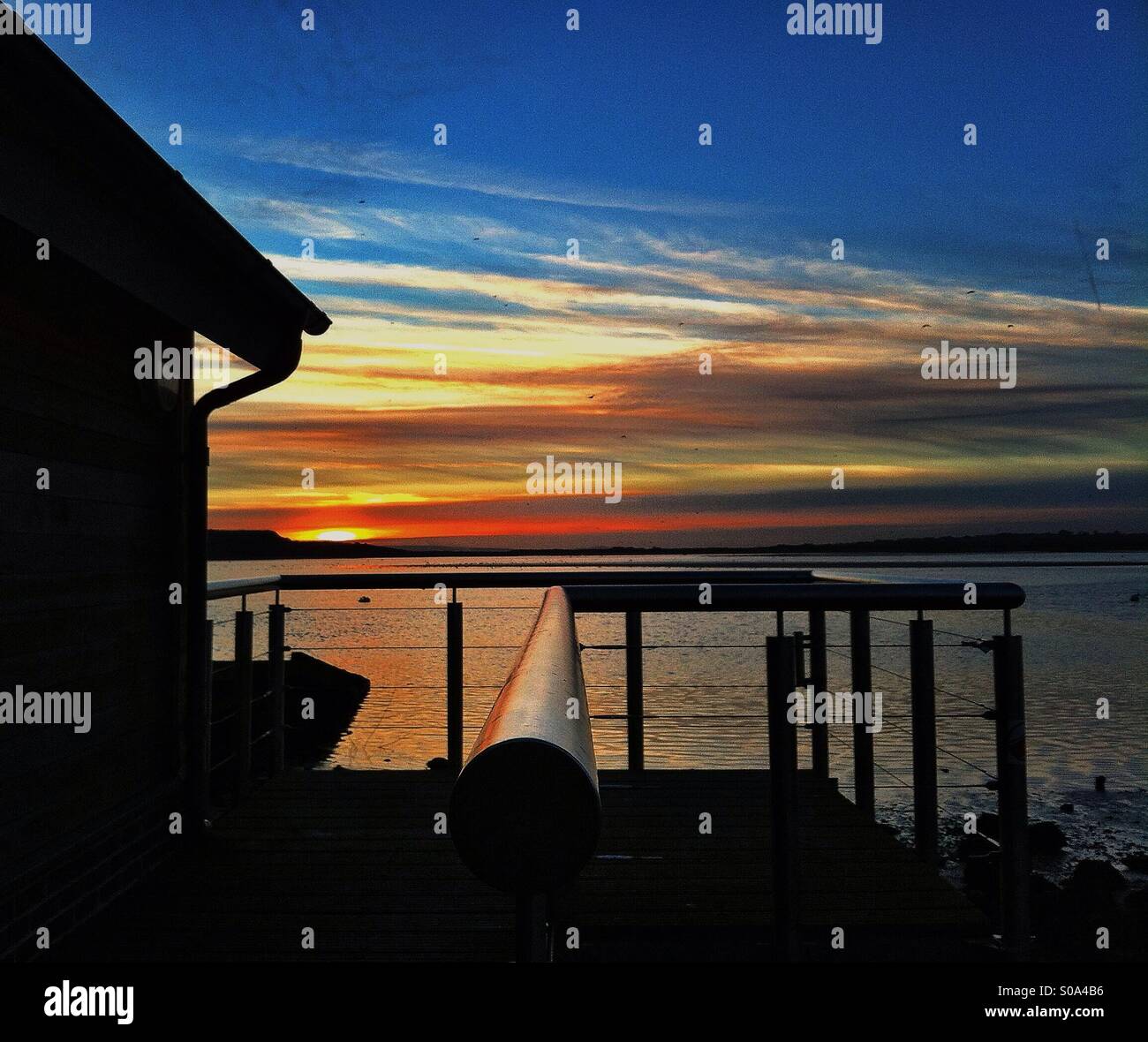 Sunset at the harbour Stock Photo - Alamy