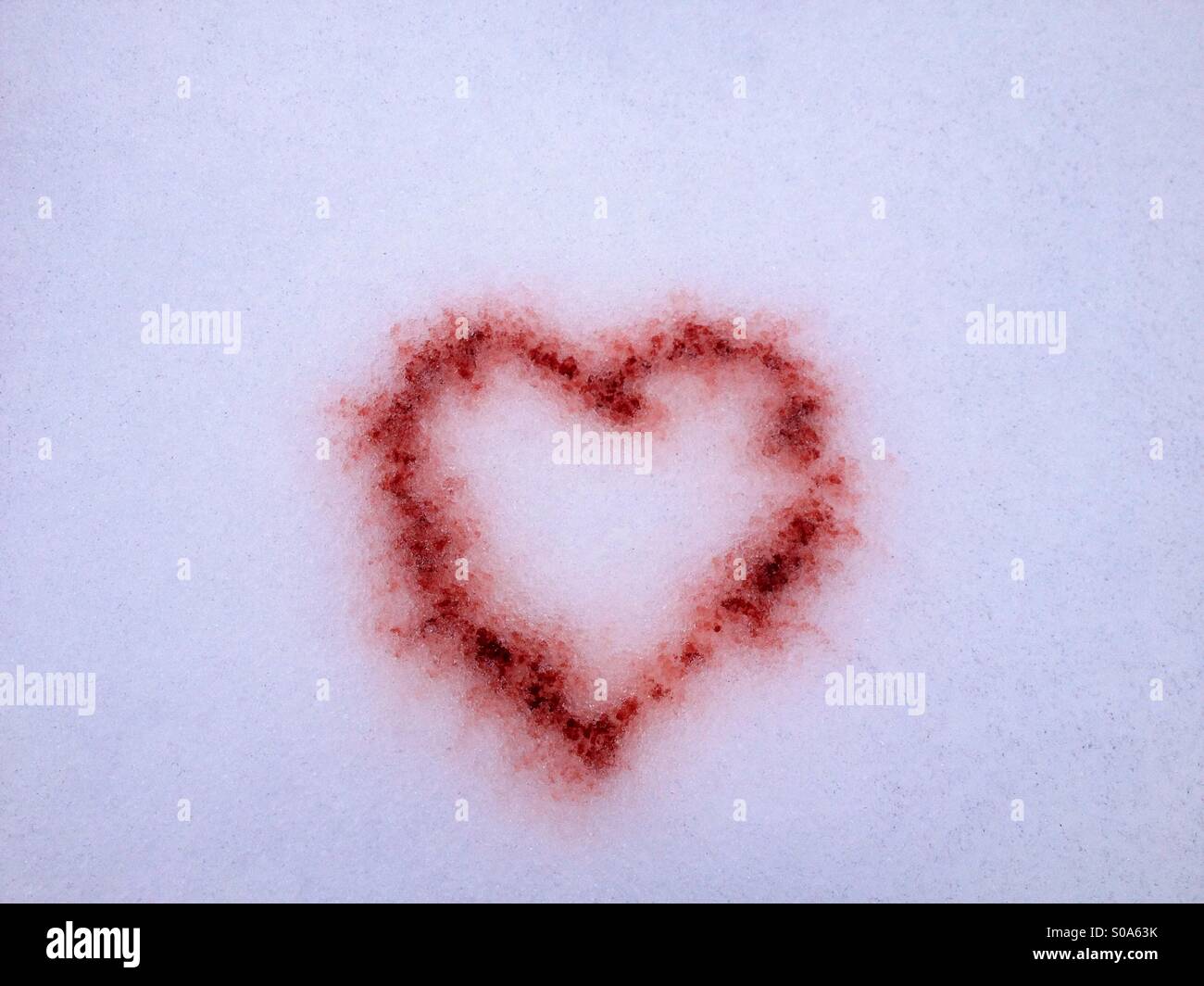 Red heart in snow Stock Photo - Alamy