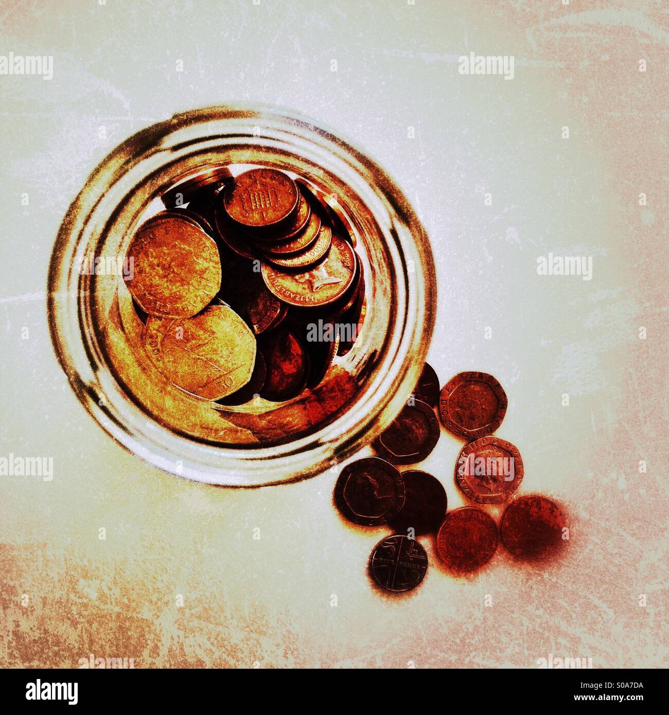 Coins in a jar Stock Photo - Alamy