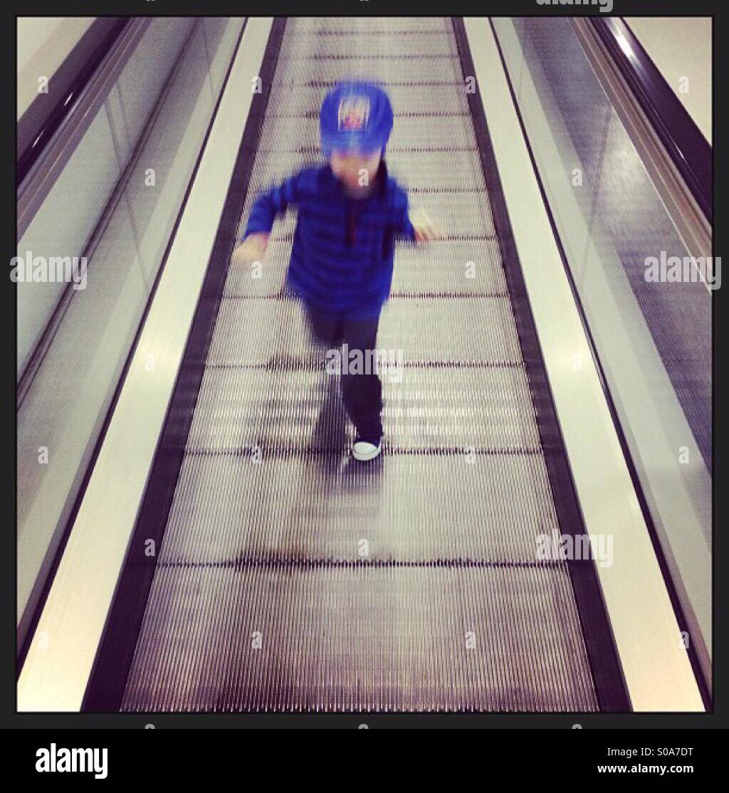 Child on escalator hi-res stock photography and images - Alamy