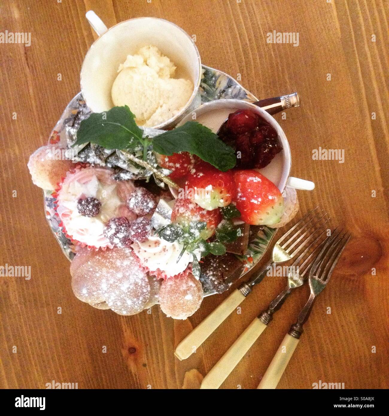 Cake for three. A selection of cakes on a cake stand with three forks ...