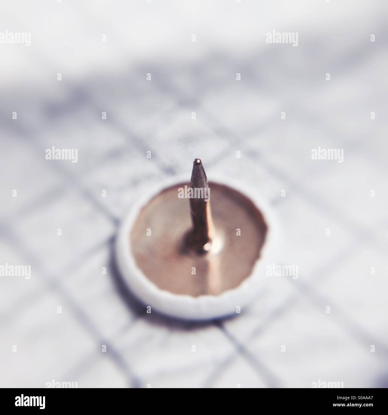 Sharp pin on squared paper Stock Photo - Alamy