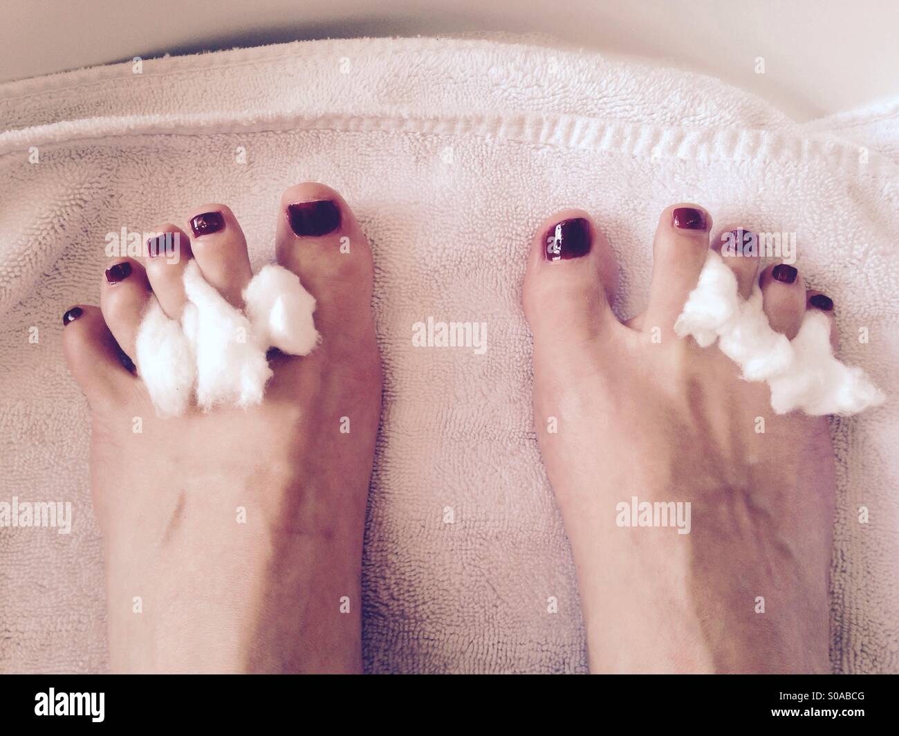 Pedicure with red nail polish Stock Photo - Alamy