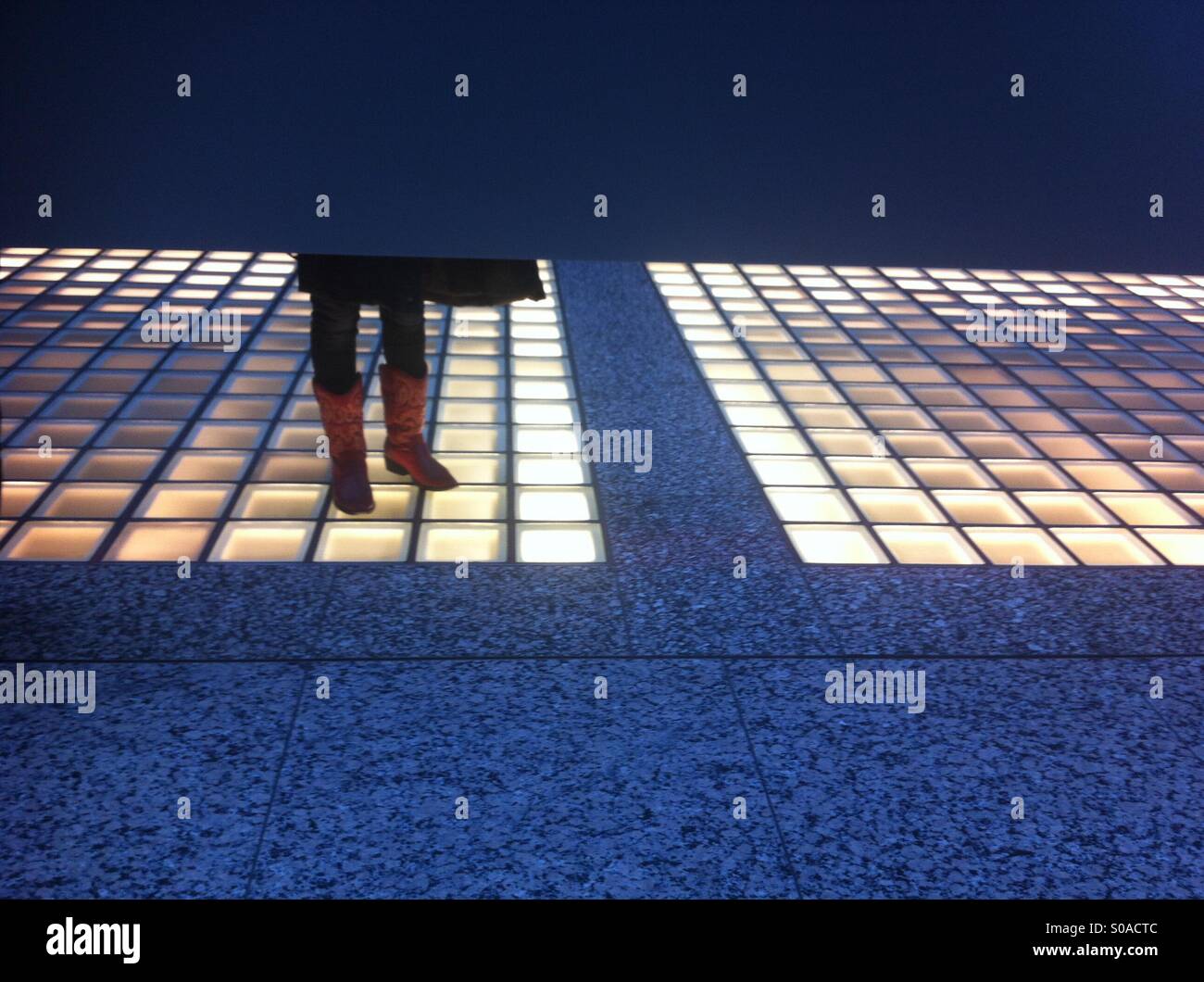 Person observing images posted to an interior photo email exhibit (legs ...