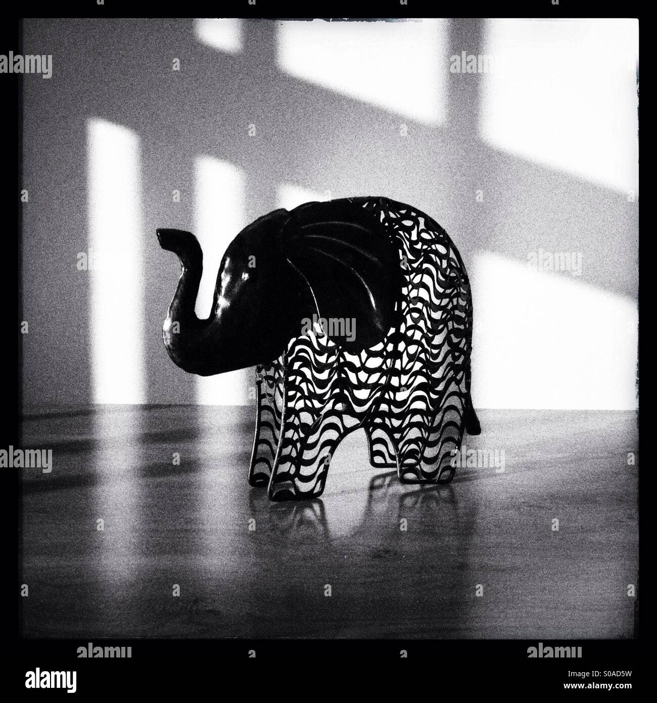 The elephant in the room; elephant ornament against some strong window ...