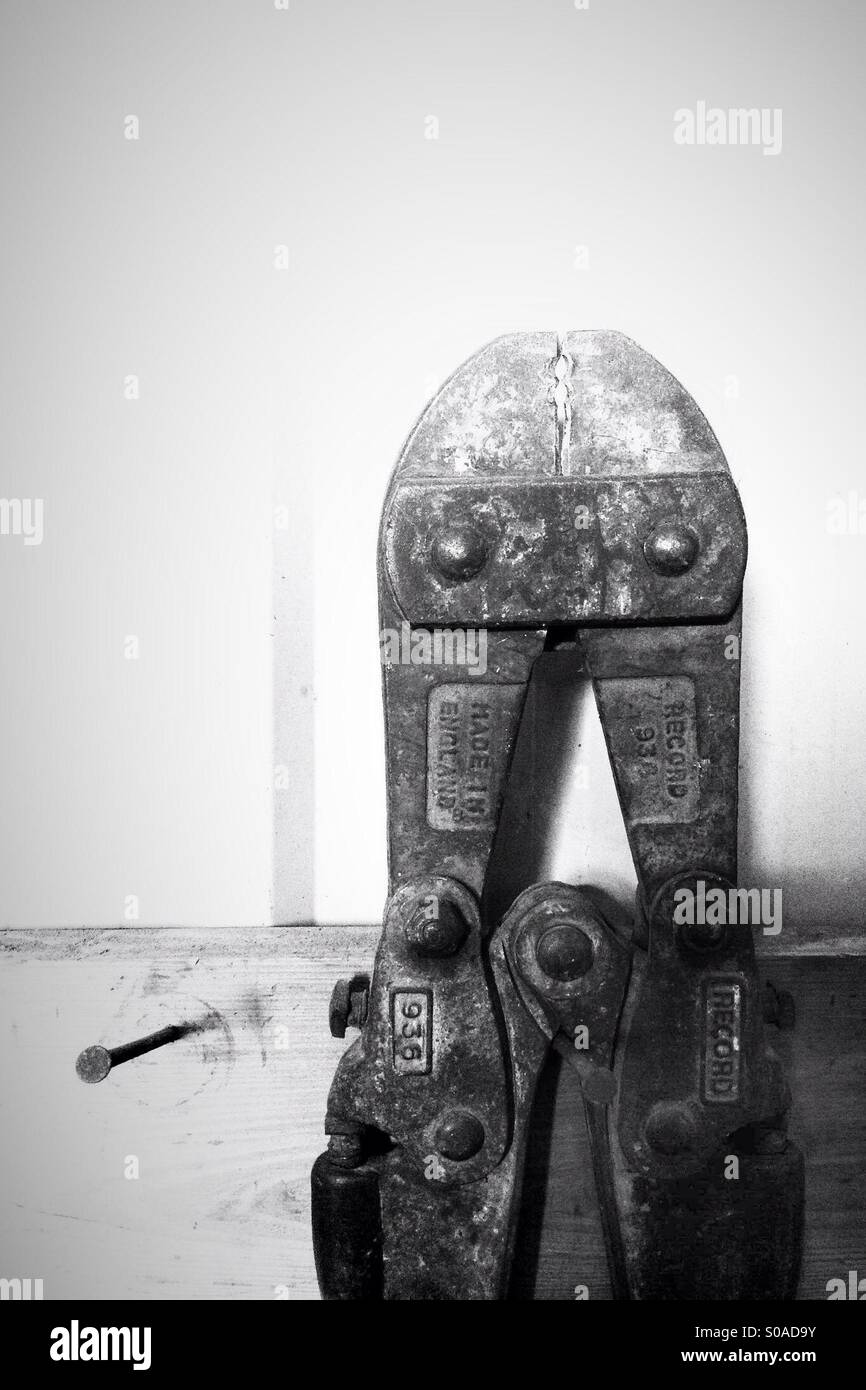 Bolt cutters hanging on a wall Stock Photo - Alamy